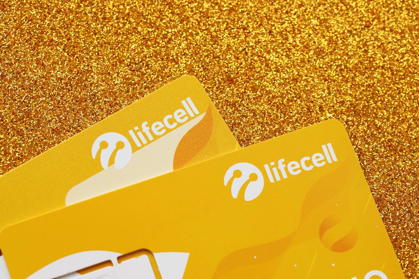Ternopil, Ukraine - April 24, 2022 Lifecell new sim card with free contract on yellow background ...