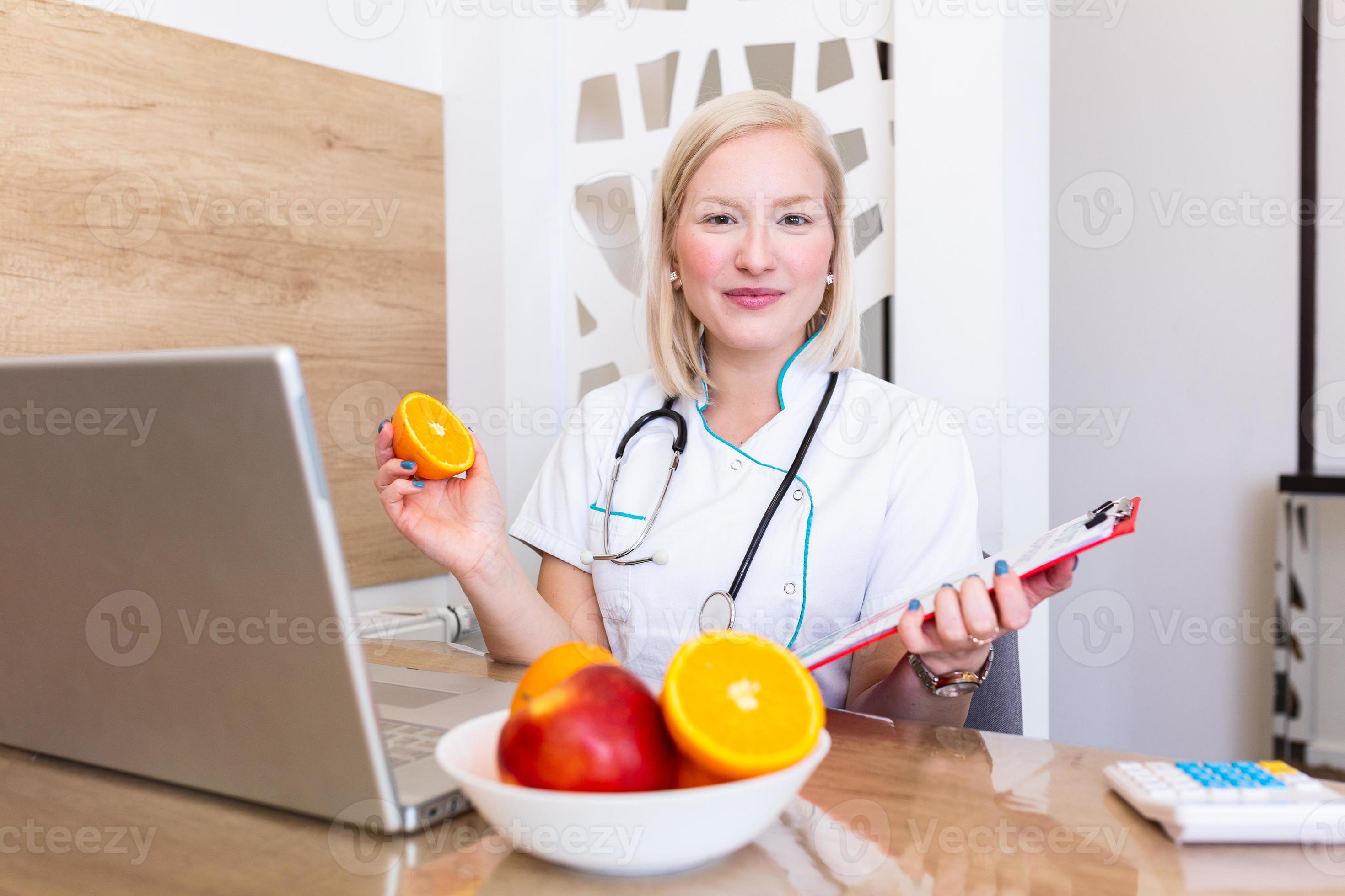 Portrait Of Young Smiling Female Nutritionist In The Consultation Room
