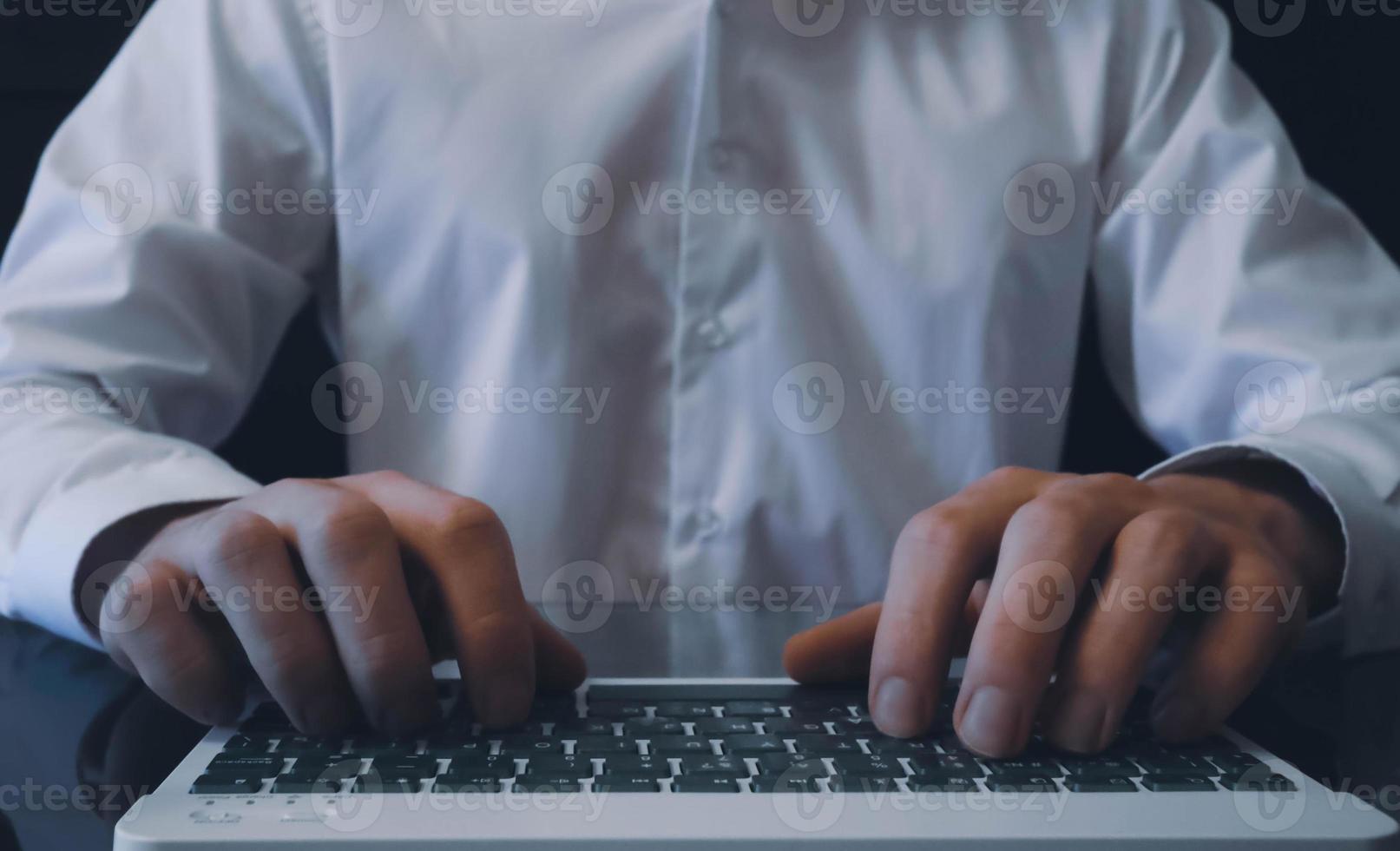Male computer user closeup concept image. Front view photo of male office worker hands typing on ...