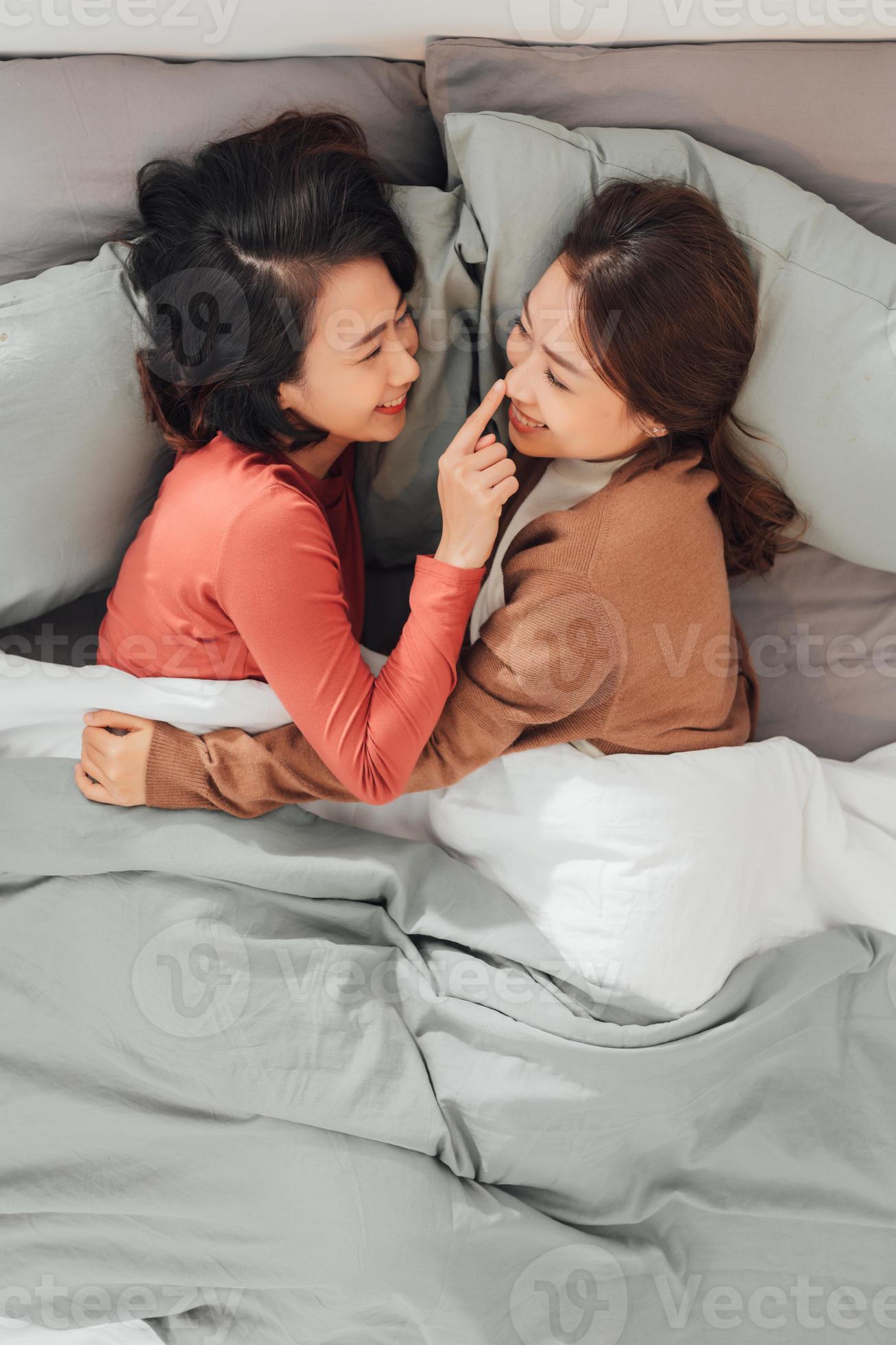 Young lesbian women in love embracing while lying don on bed at home. 11812276 Stock Photo at ...