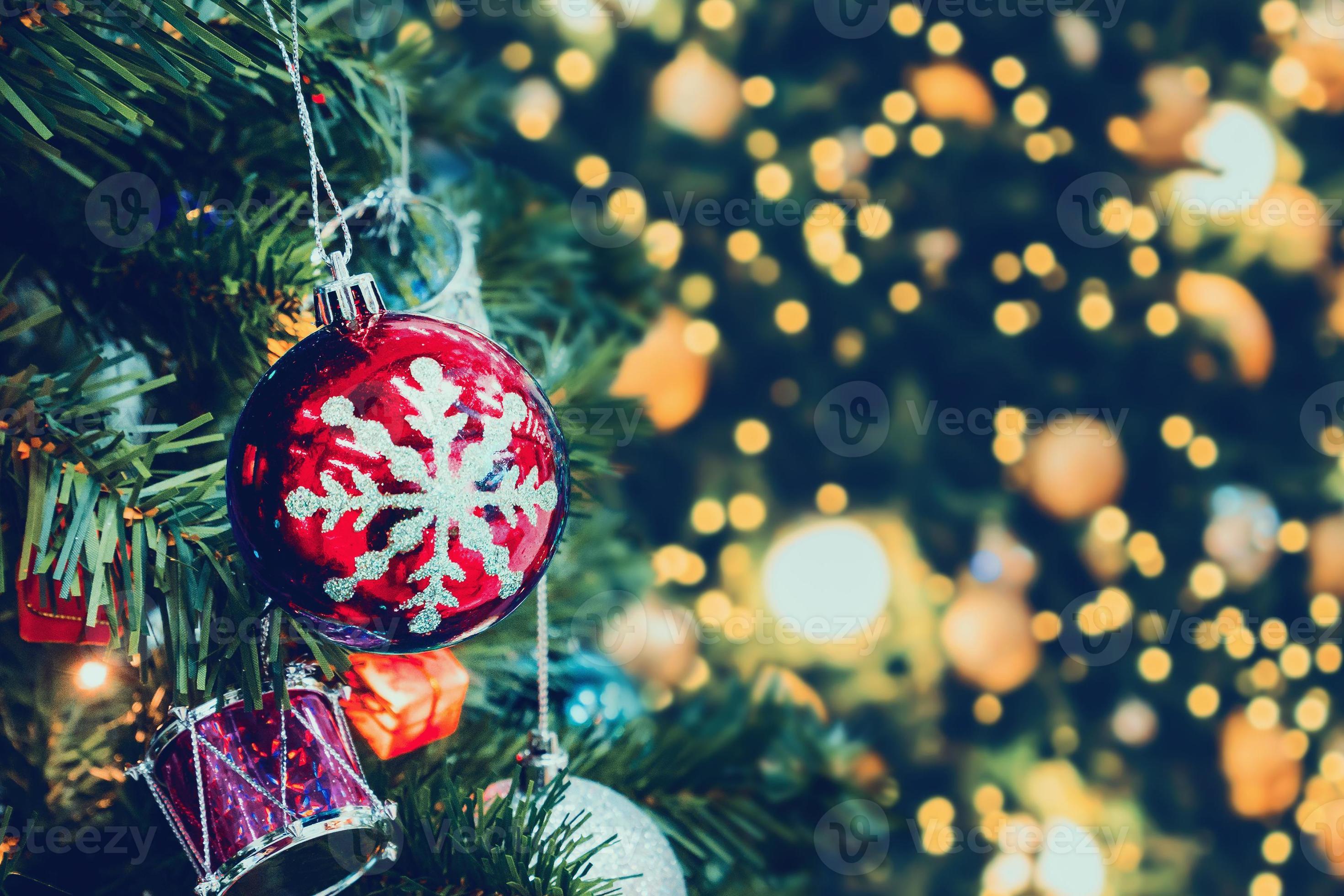 Decorated Christmas tree with colorful bauble on sparkling bokeh light blurred background ...