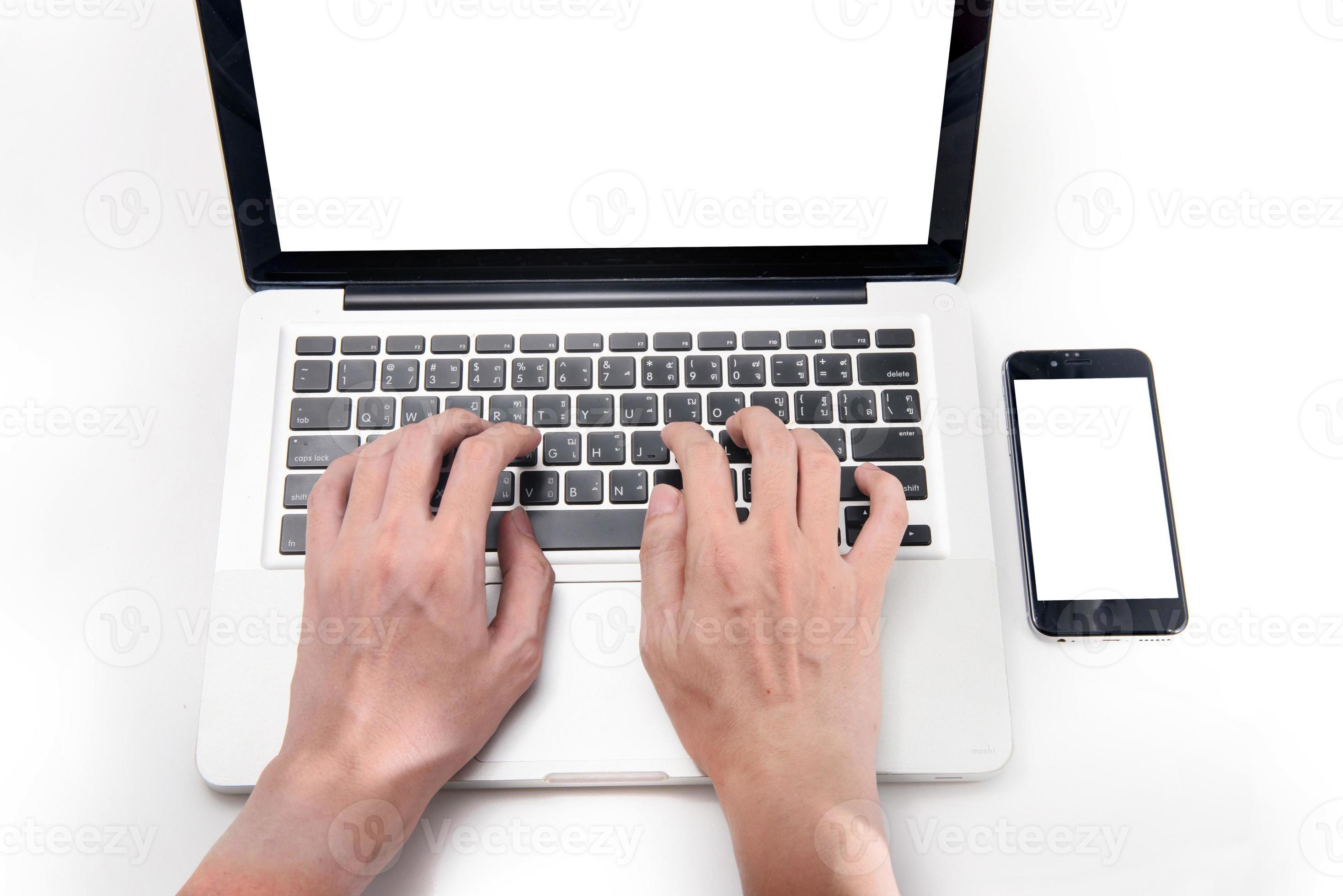 man typing on a laptop keyboard on white background, top view, hands ...