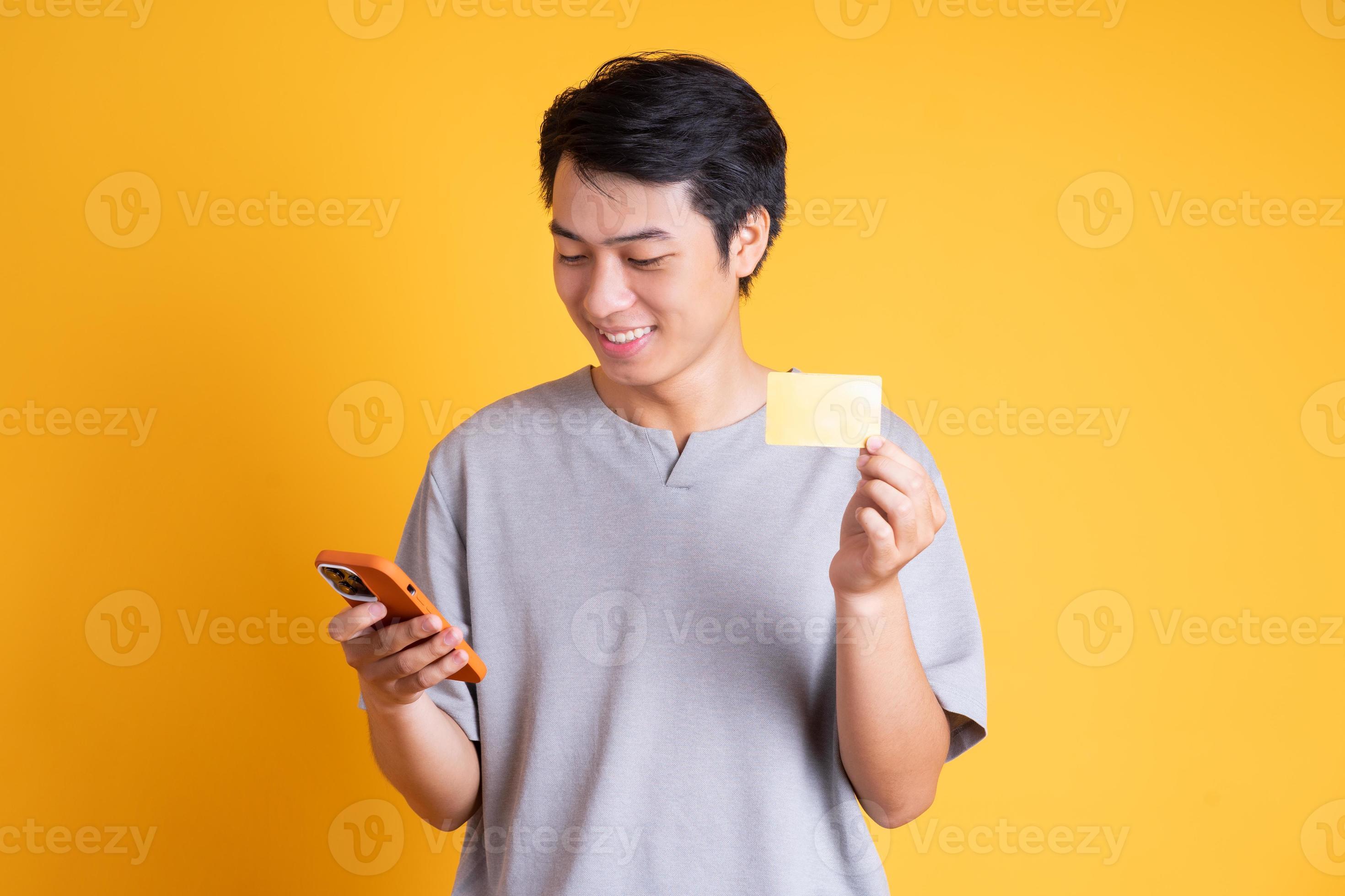 Asian young man posing on a yellow background 11869410 Stock Photo at ...