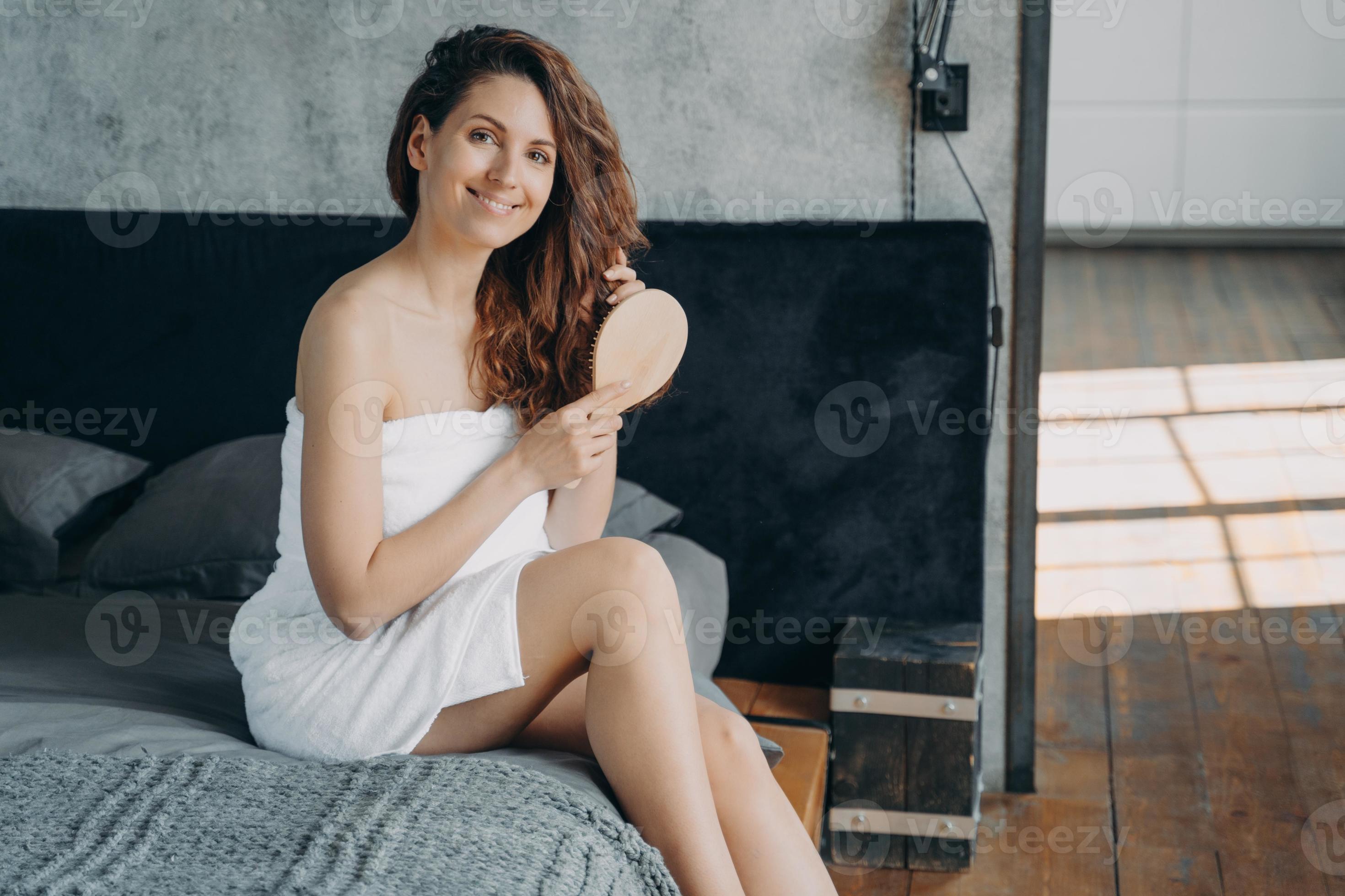 Young Girl Brushes Long Hair With Hairbrush Sitting On Bed After Shower Haircare Natural
