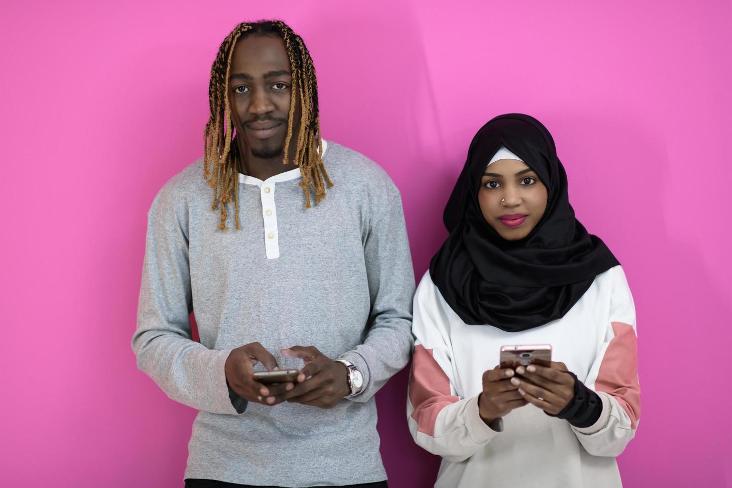 Young African American Couple Laughing Using Smartphones Apps Isolated