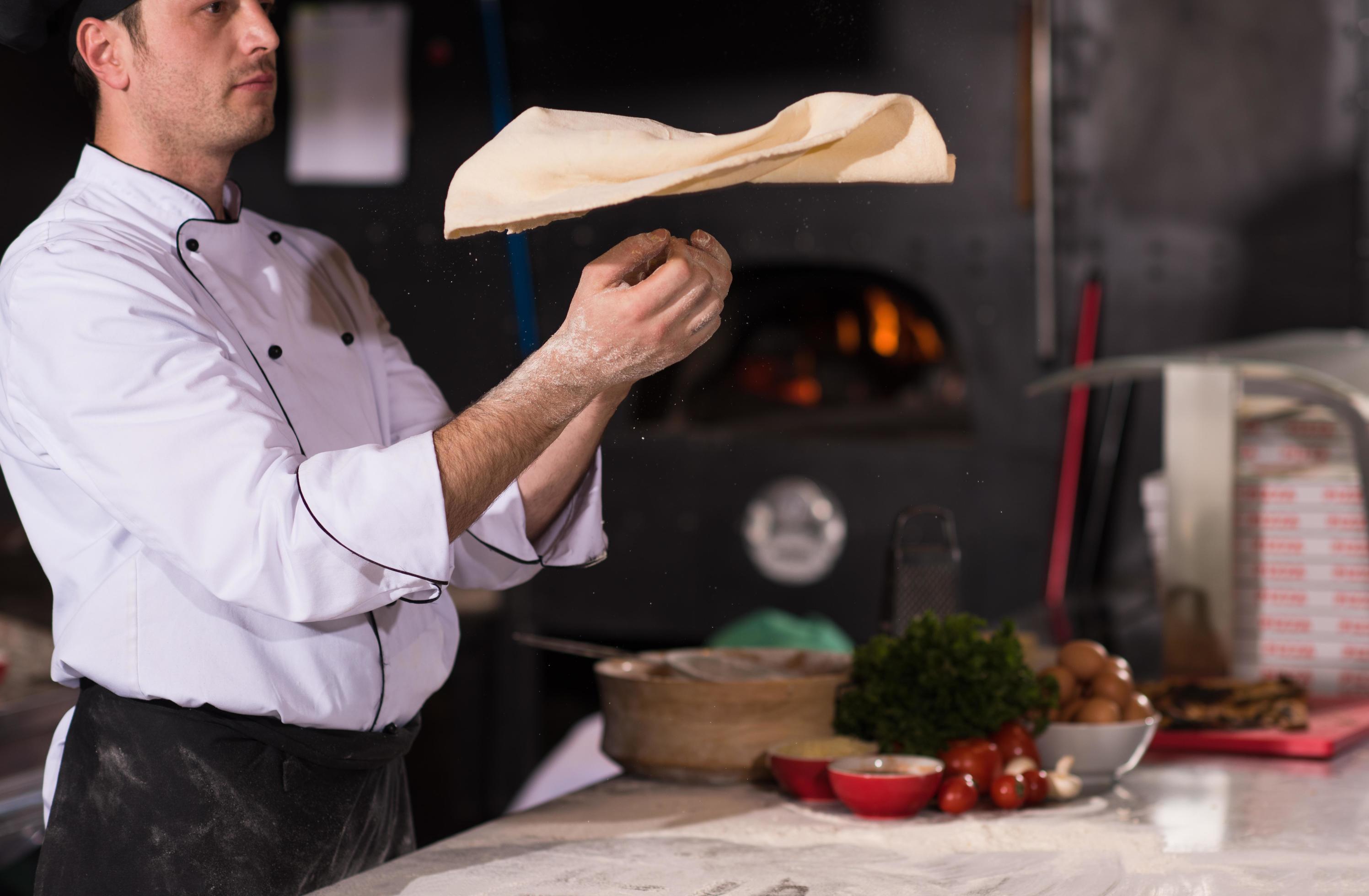 chef throwing up pizza dough 12086868 Stock Photo at Vecteezy