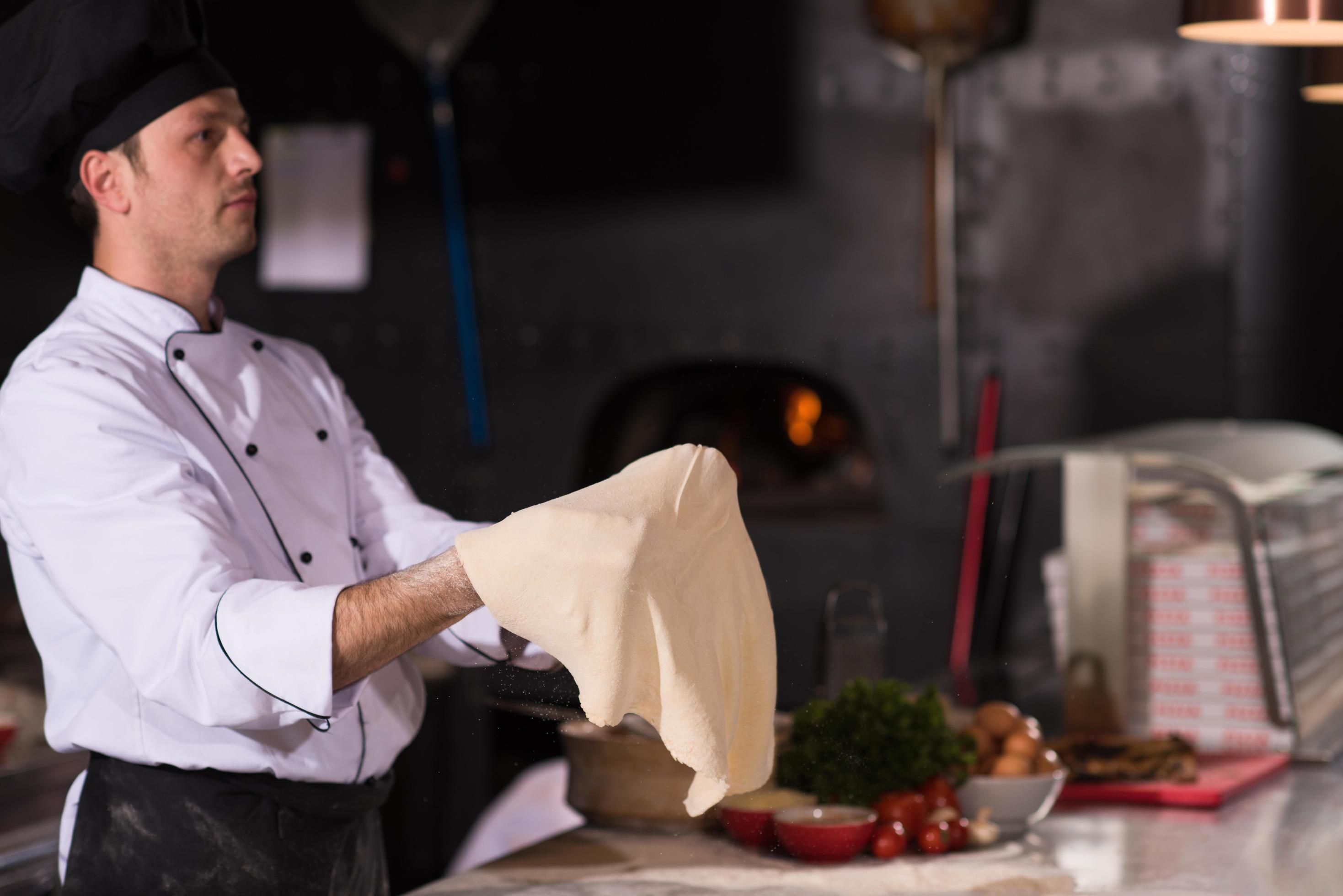 chef throwing up pizza dough 12111061 Stock Photo at Vecteezy