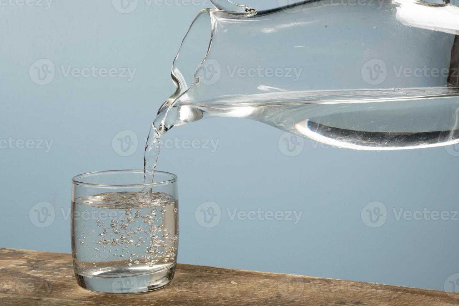 person filling a cup of water with a jar. 12190442 Stock Photo at Vecteezy