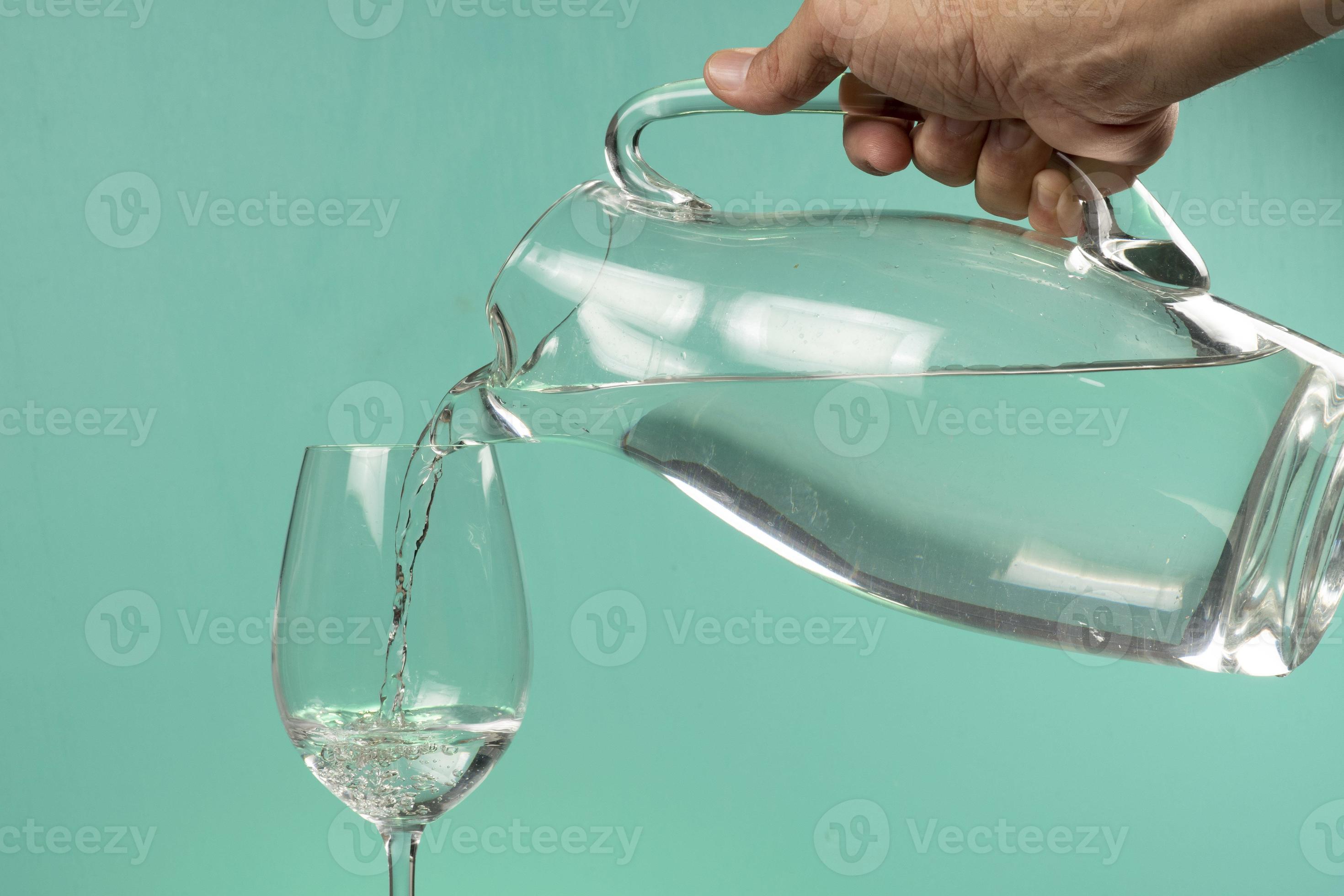 person filling a cup of water with a jar. 12191860 Stock Photo at Vecteezy