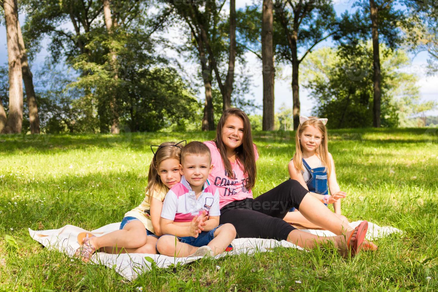 Portrait of four siblings in the park. 12347586 Stock Photo at Vecteezy