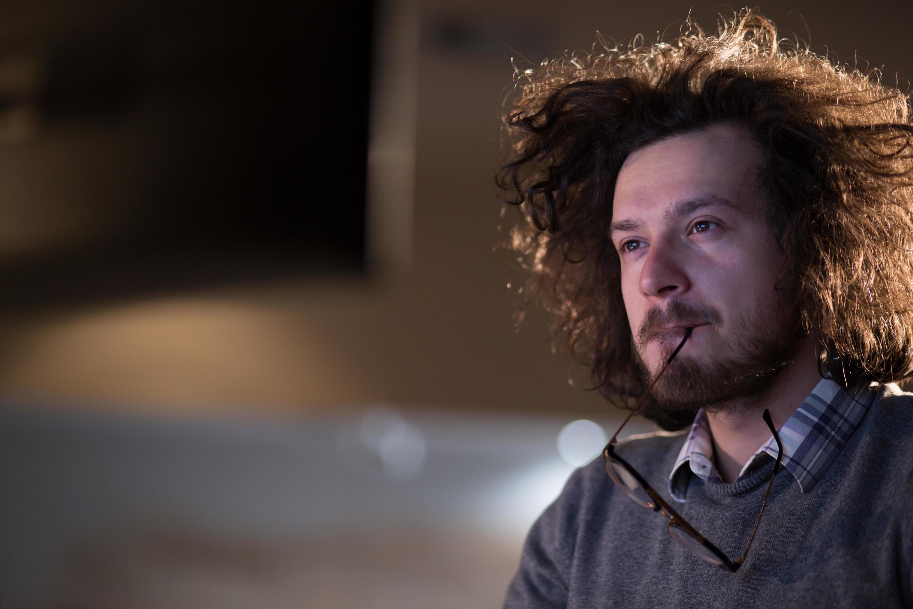 man working on computer in dark office 12401681 Stock Photo at Vecteezy