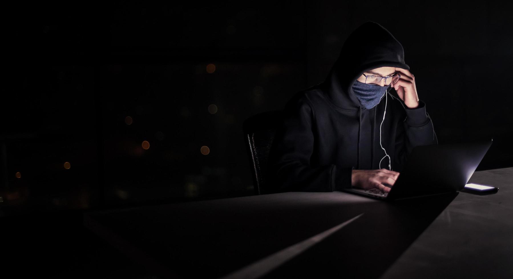 hacker usando una computadora portátil mientras trabaja en una oficina ... hacker usando una computadora portátil mientras trabaja en una oficina ...