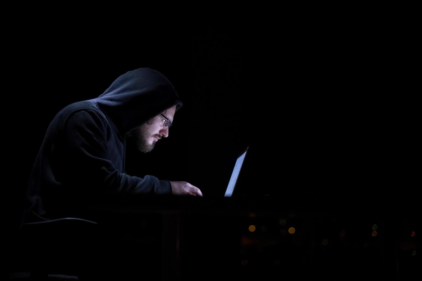 Hacker Using Laptop Computer While Working In Dark Office 12450127