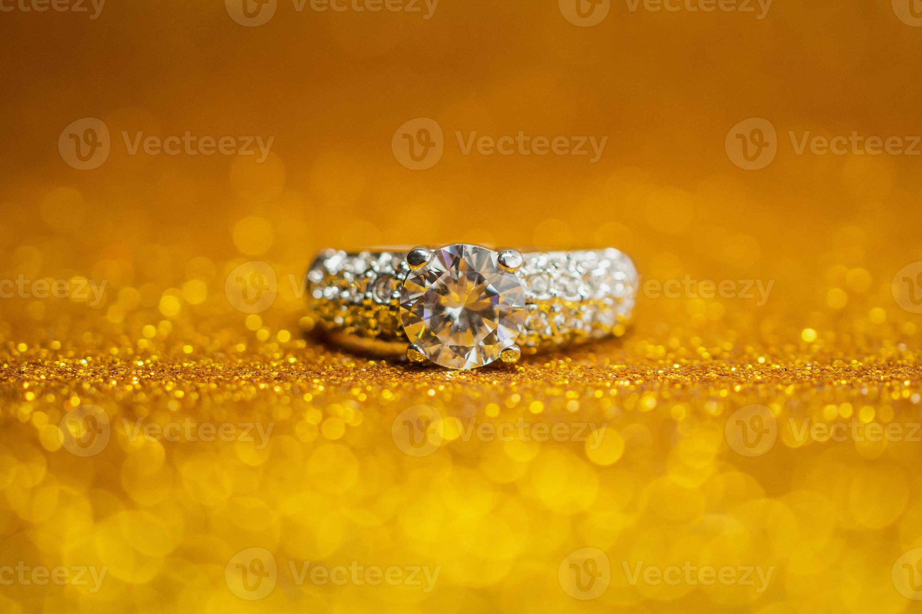 Jewelry wedding diamond ring on golden glitter bokeh light background 12471572 Stock Photo at ...