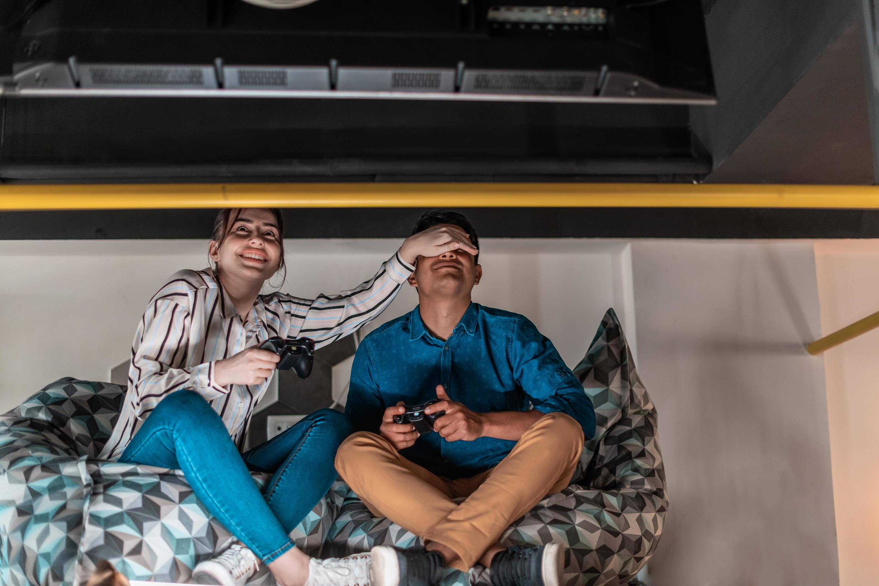 Work hard play hard. Workers Playing computer games man against woman during break in relaxation ...