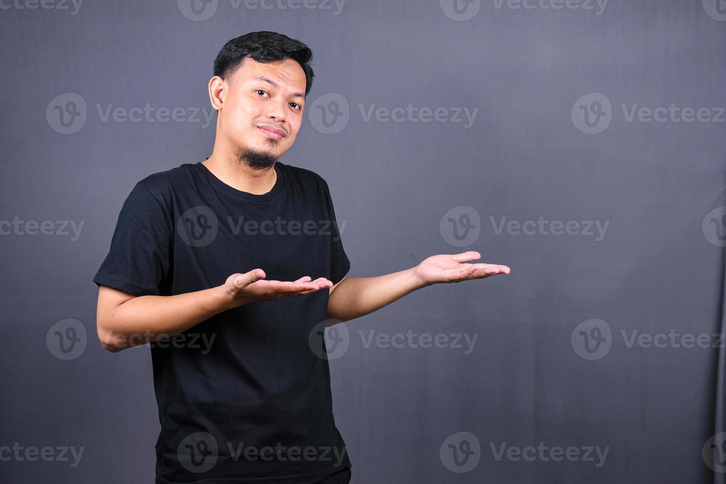 Closeup portrait asian young man shrugging shoulders. I don't know ...