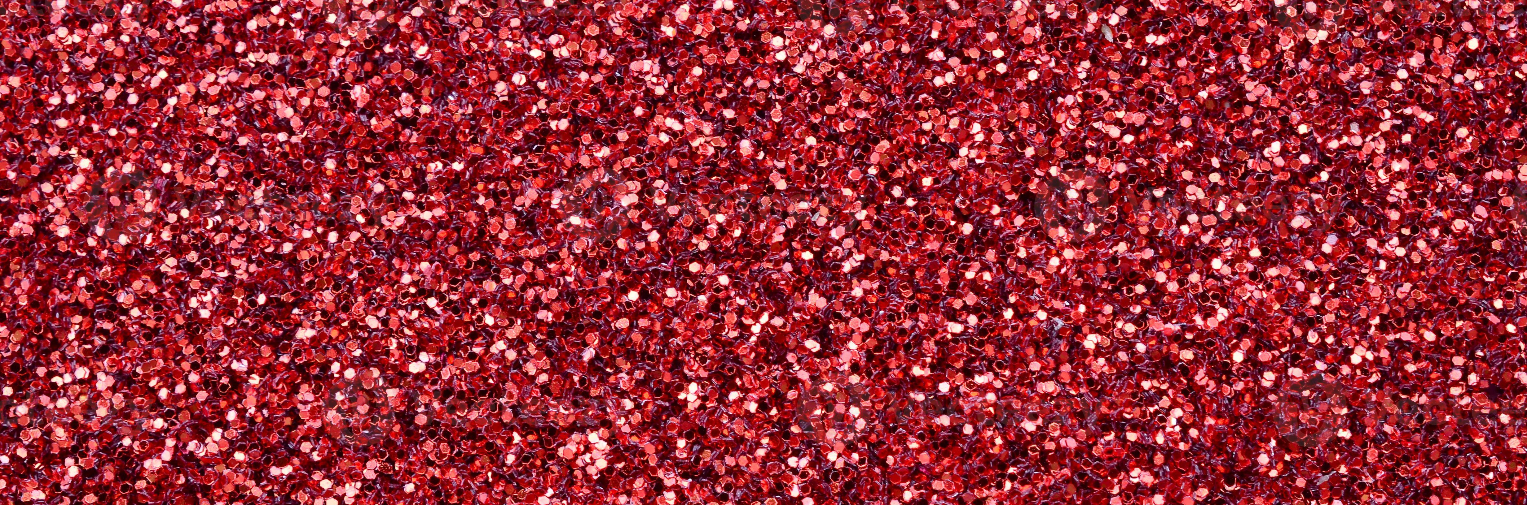 A huge amount of red decorative sequins. Background texture with shiny ...