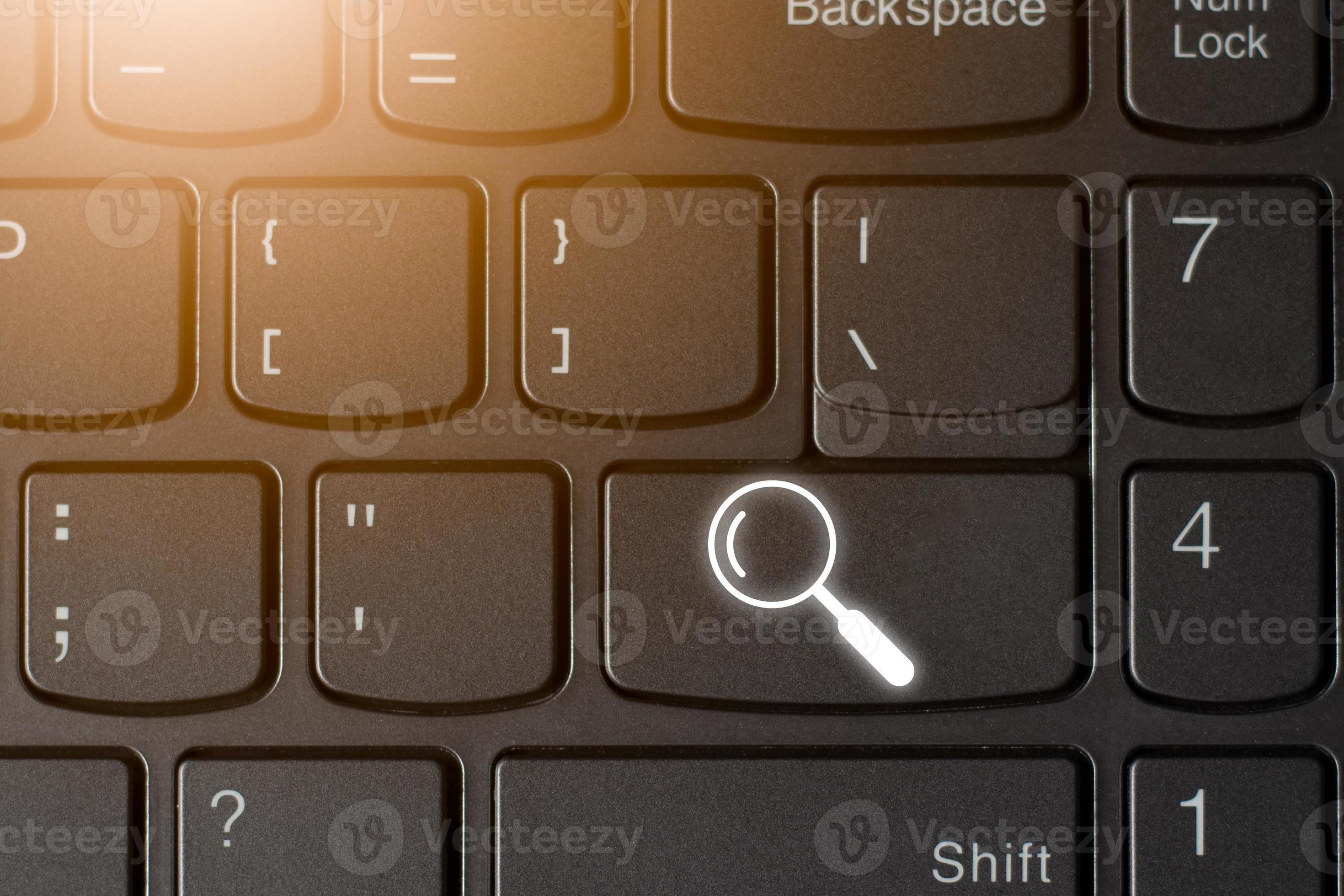 Search icon symbol on the computer key board with computer light ...