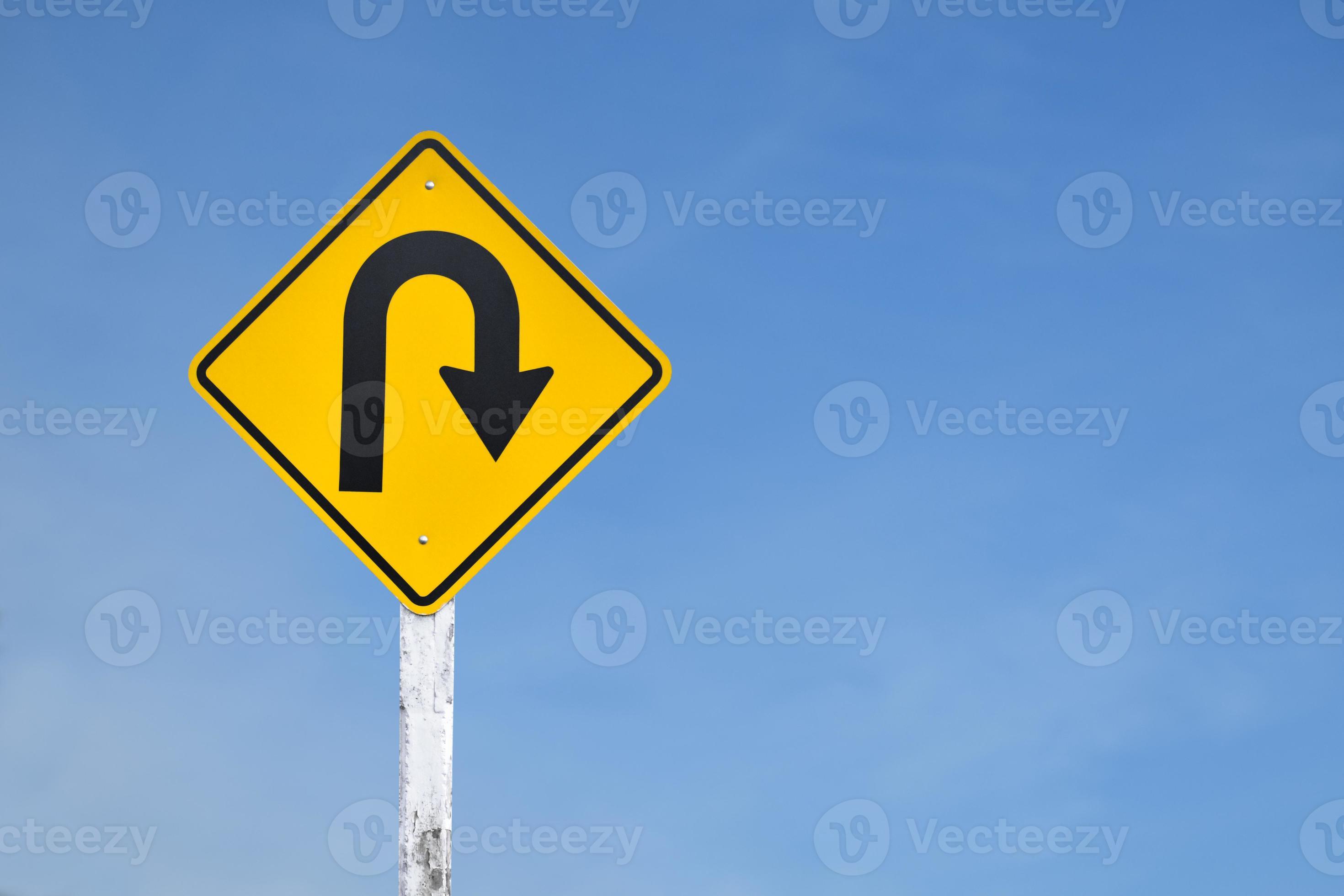 Traffic warning sign on pole, right curve means the way ahead is a right curve and should slow ...