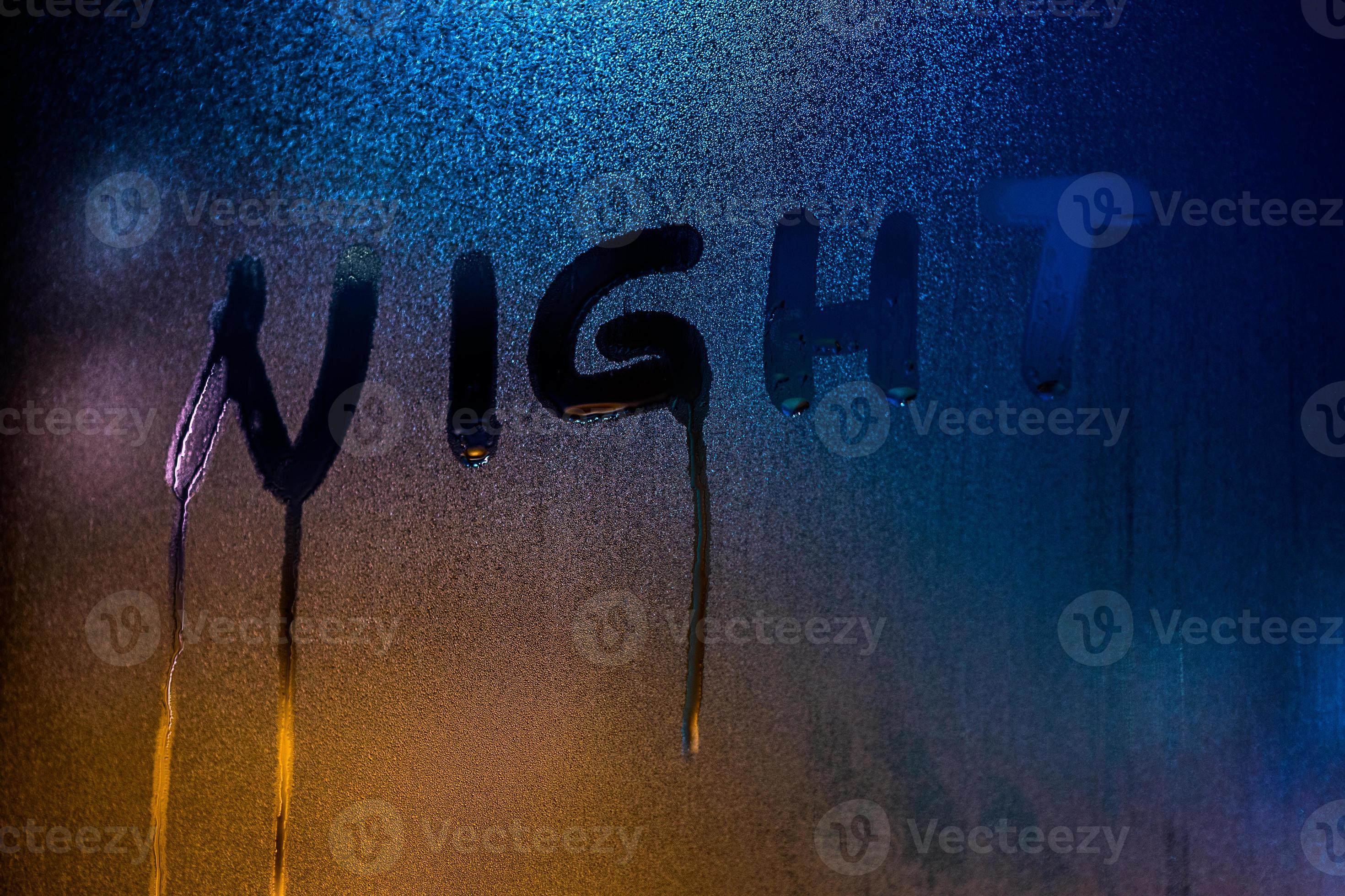 Word Night Handwritten By Finger On Nightime Wet Window Glass Close Up