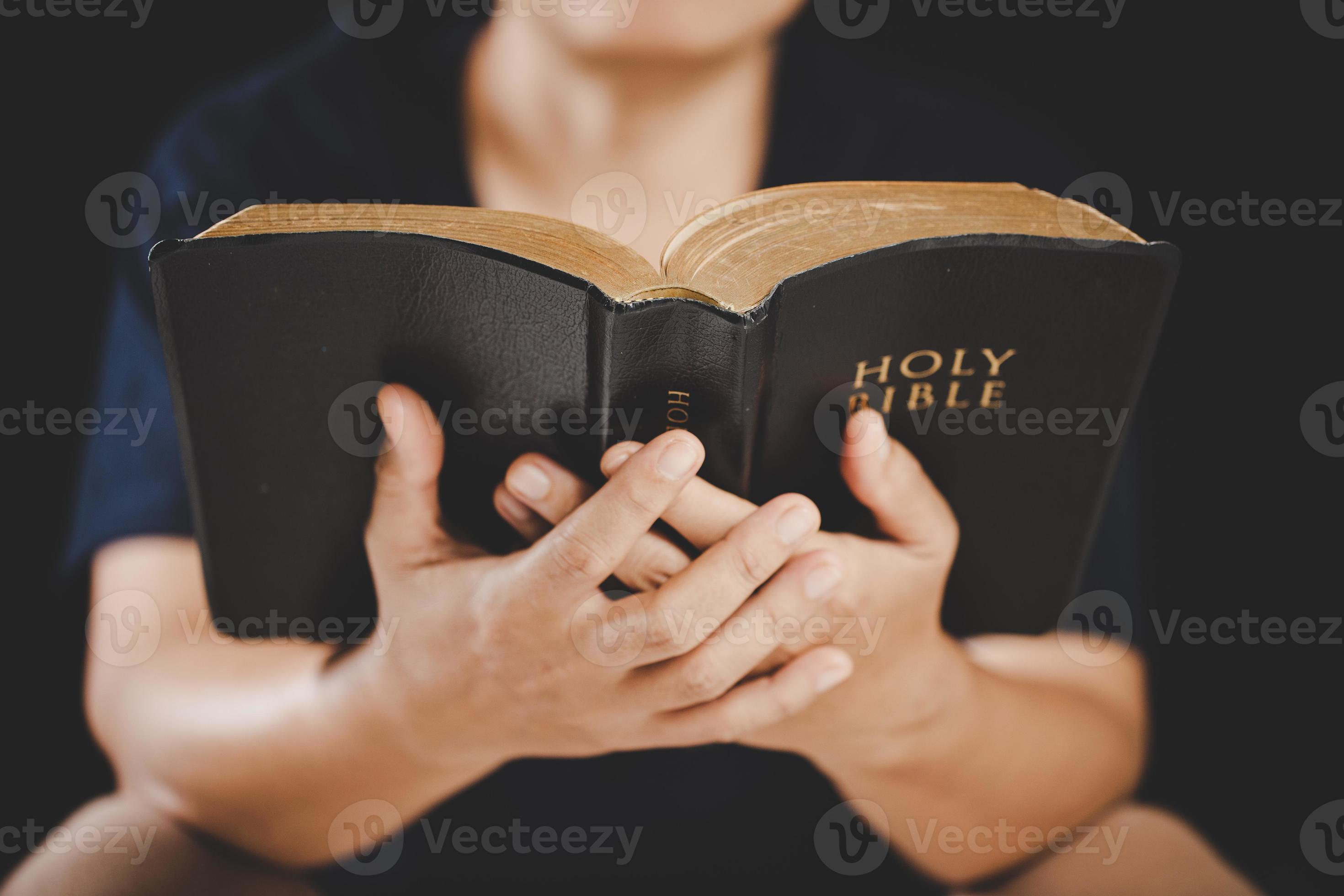 Young woman person hand holding holy bible with study at home. Adult female christian reading ...