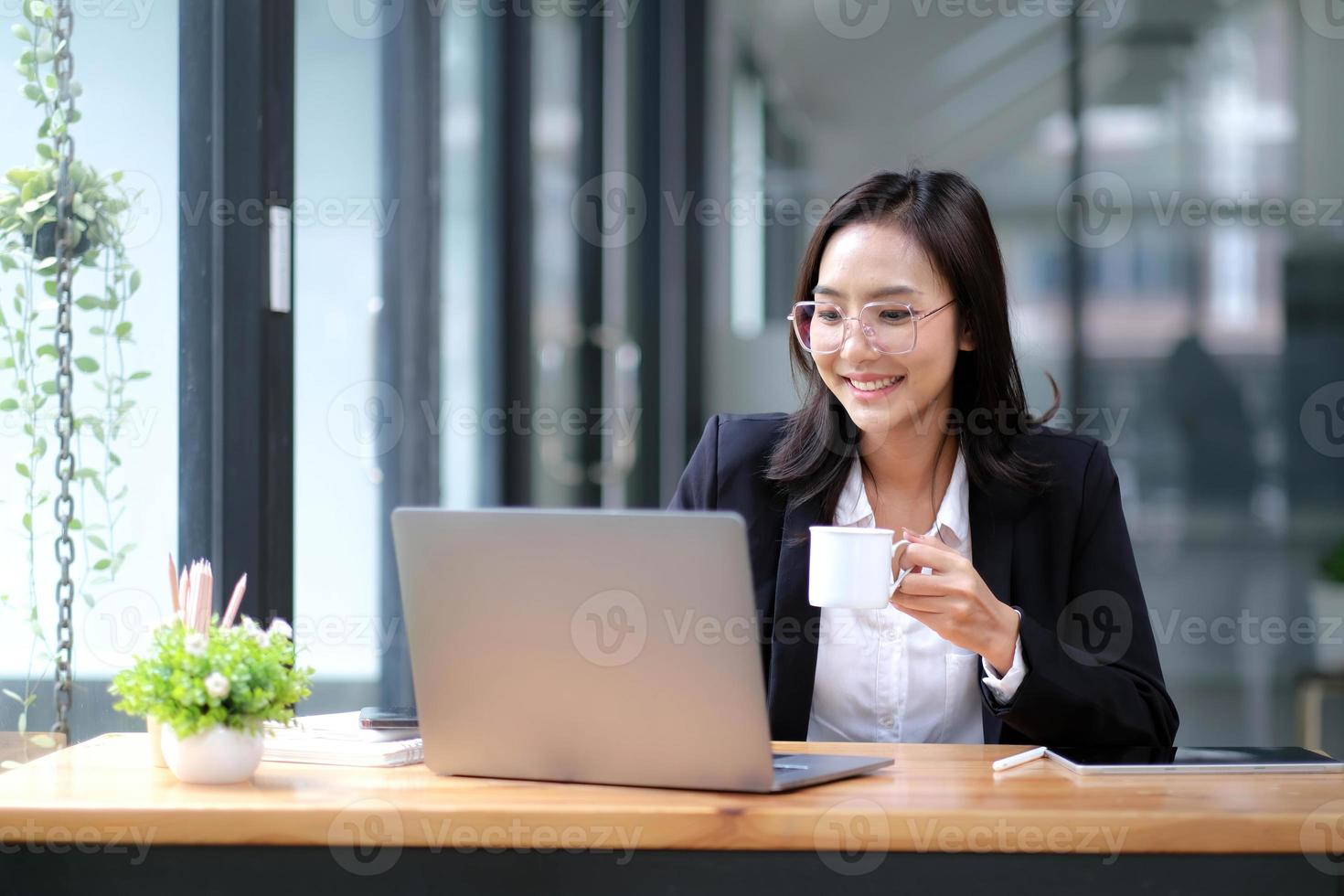 Professional asian businesswoman or female manager sits at her office ...