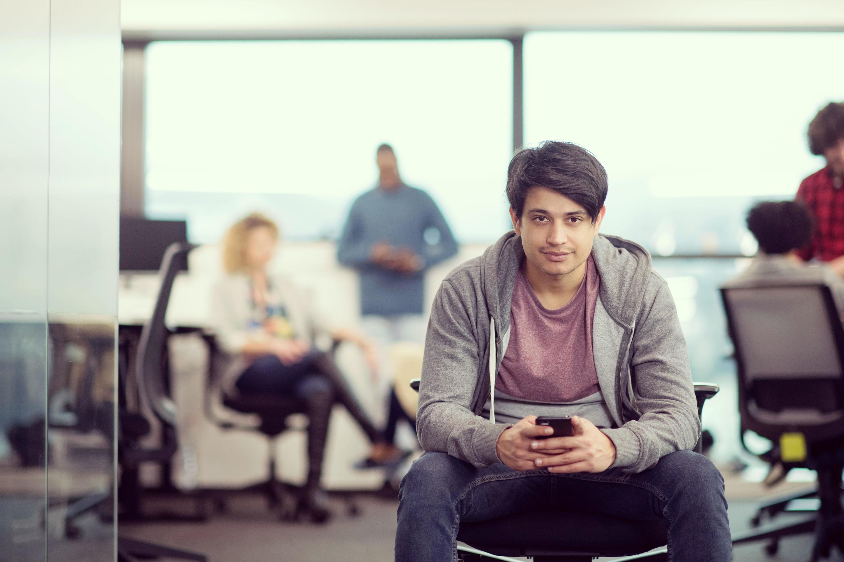 software developer using mobile phone 12710028 Stock Photo at Vecteezy