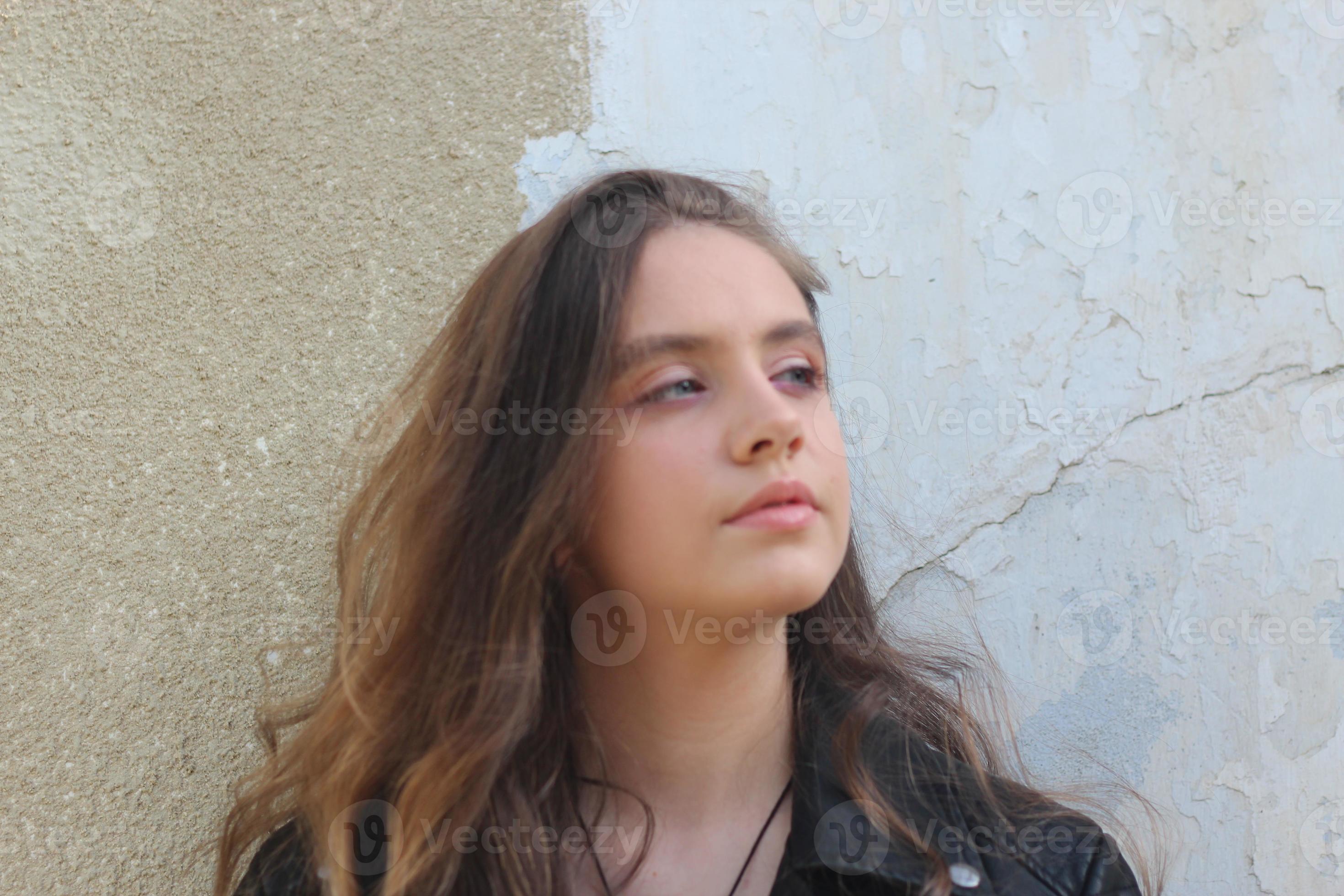 dark-haired girl with wavy hair outdoors, portrait of a teenager 12725979 Stock Photo at Vecteezy