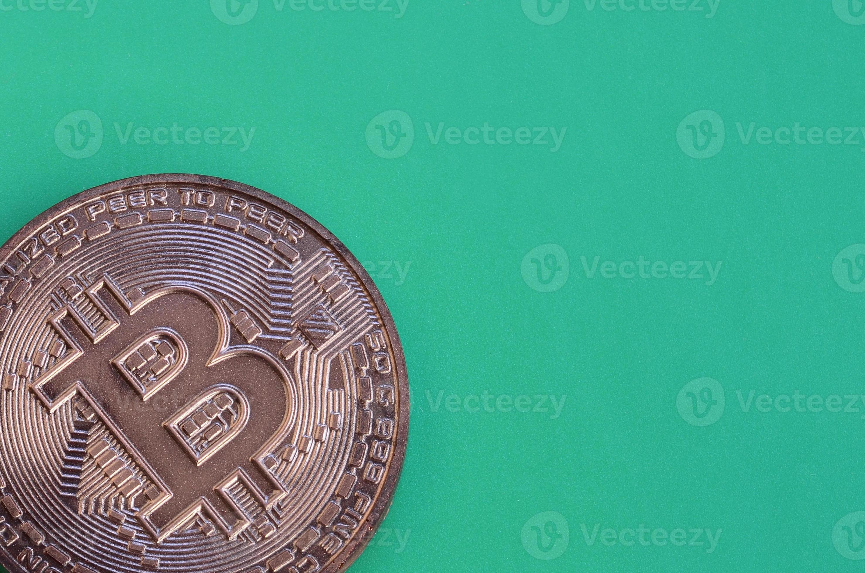 Chocolate product in the form of physical bitcoin lies on a green ... Chocolate product in the form of physical bitcoin lies on a green ...