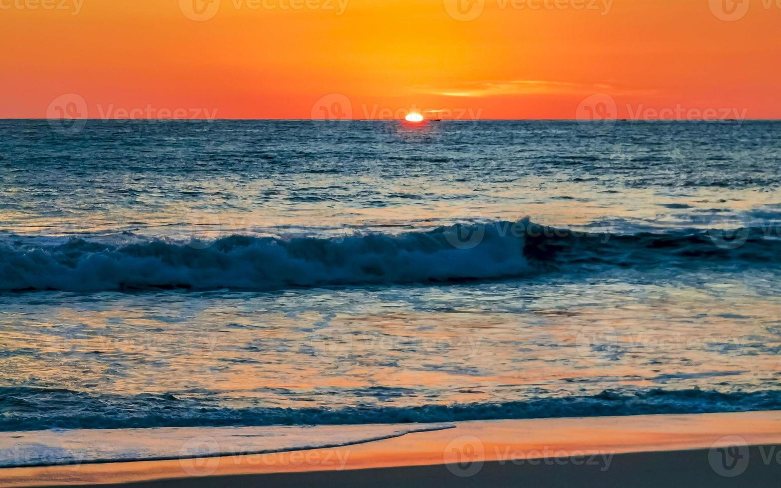 Colorful golden sunset big wave and beach Puerto Escondido Mexico ...