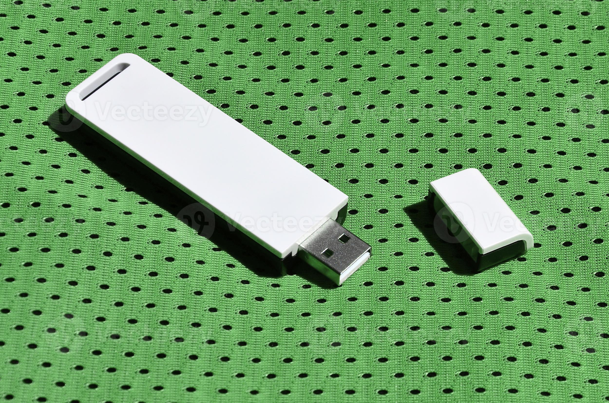 A Modern Portable Usb Wi Fi Adapter Is Placed On The Green Sportswear Made Of Polyester Nylon