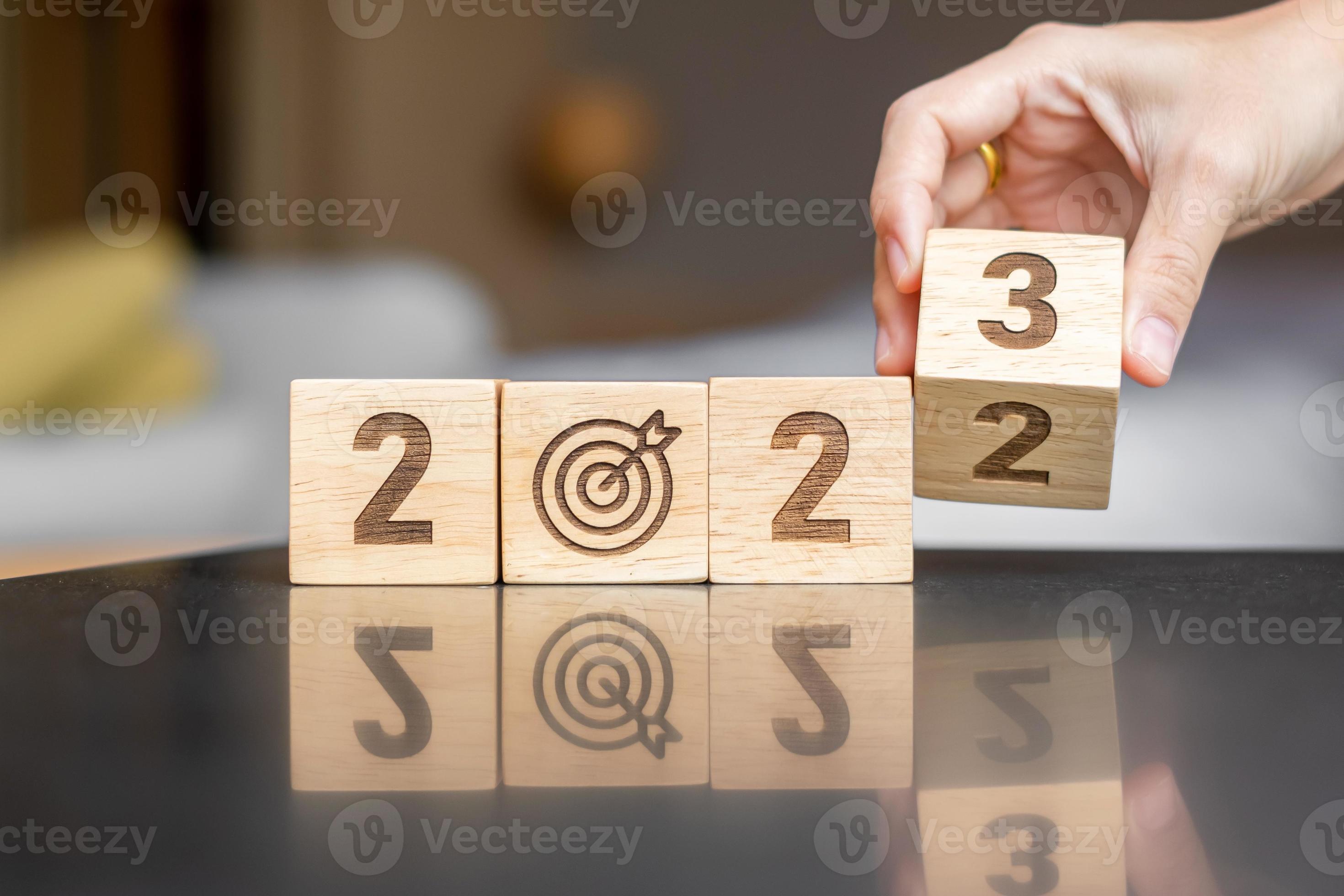 hand flip 2022 to 2023 block with dartboard sign. Business Goal, Target, Resolution, strategy ...