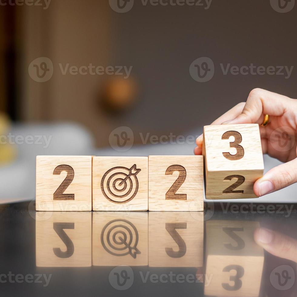 hand flip 2022 to 2023 block with dartboard sign. Business Goal, Target, Resolution, strategy ...