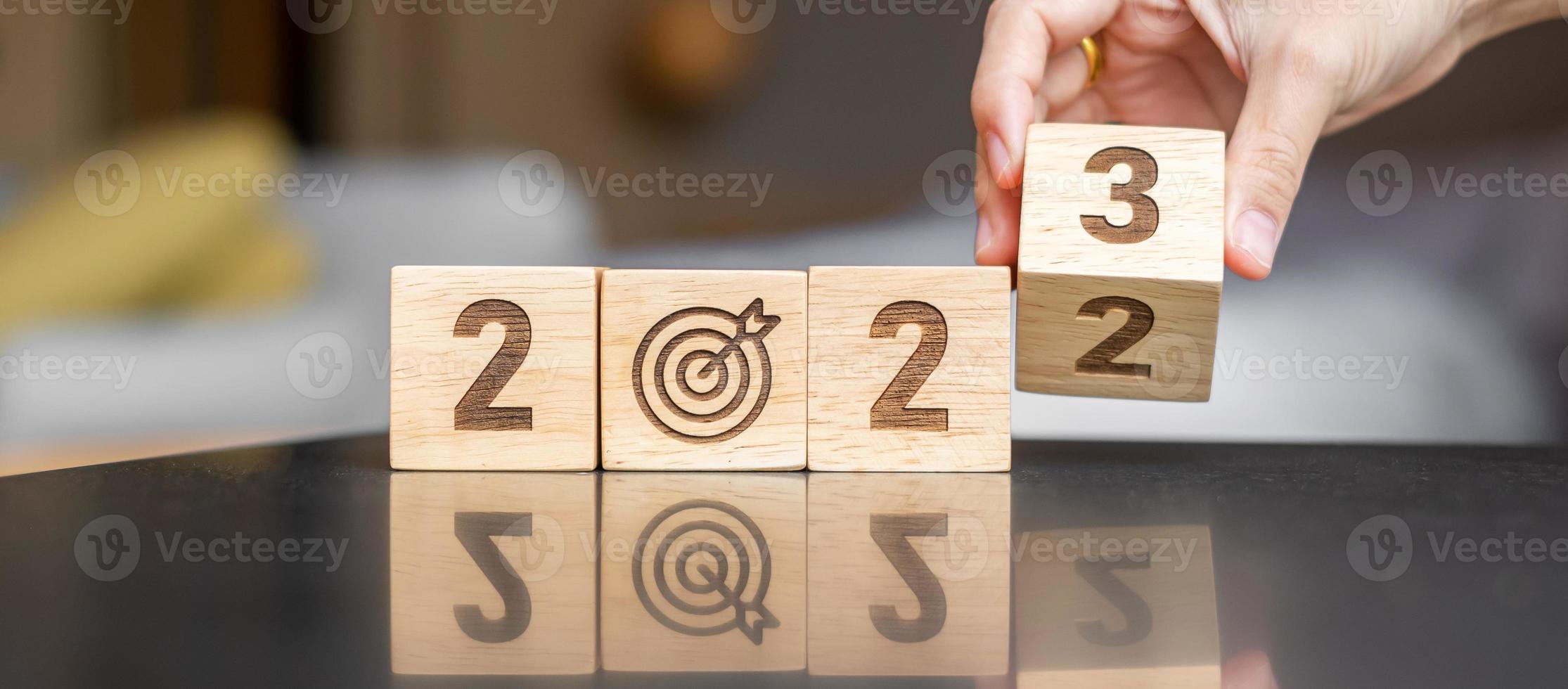 hand flip 2022 to 2023 block with dartboard sign. Business Goal, Target, Resolution, strategy ...