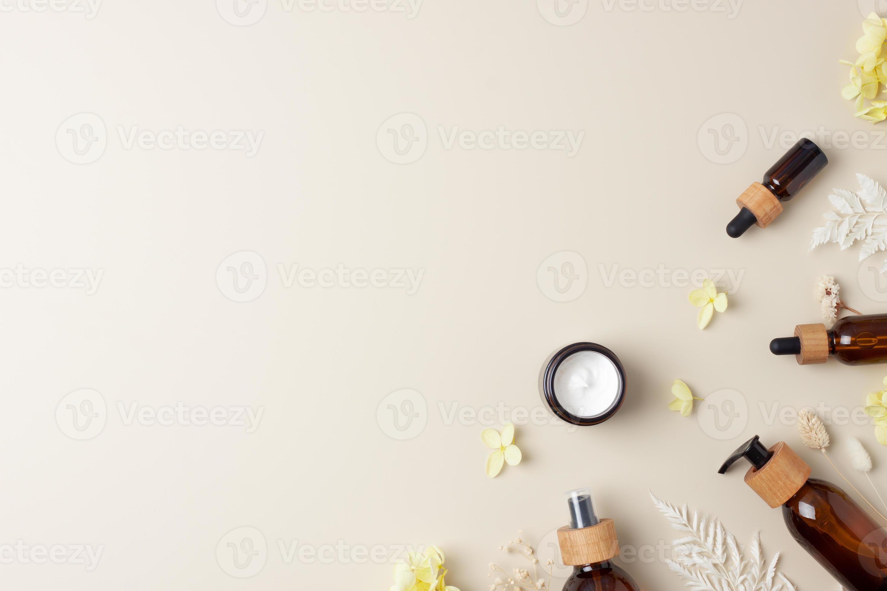 Cosmetic Skin Care Products With Flowers On Pastel Beige Background Flat Lay Copy Space