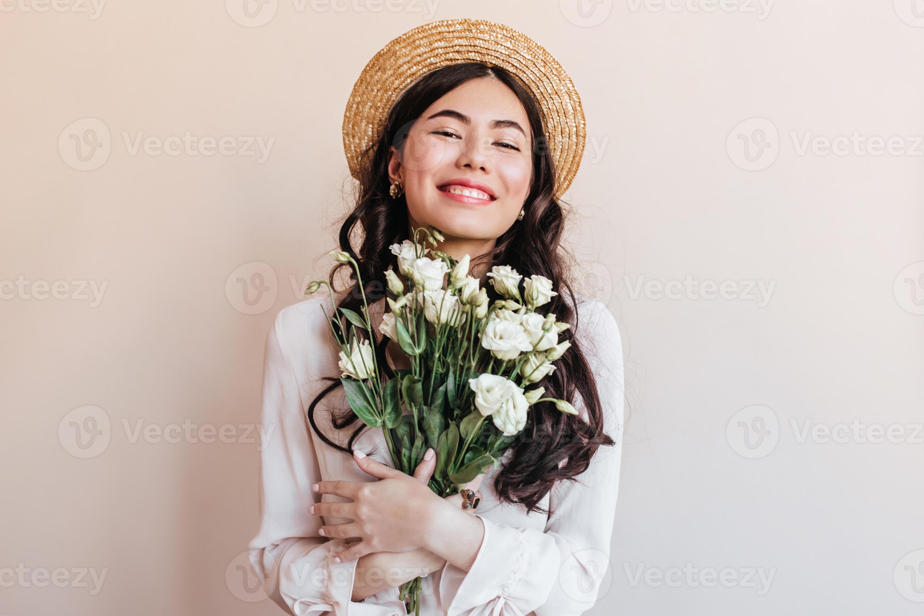 Cheerful Asian Girl In Straw Hat Holding Flowers Young Woman With