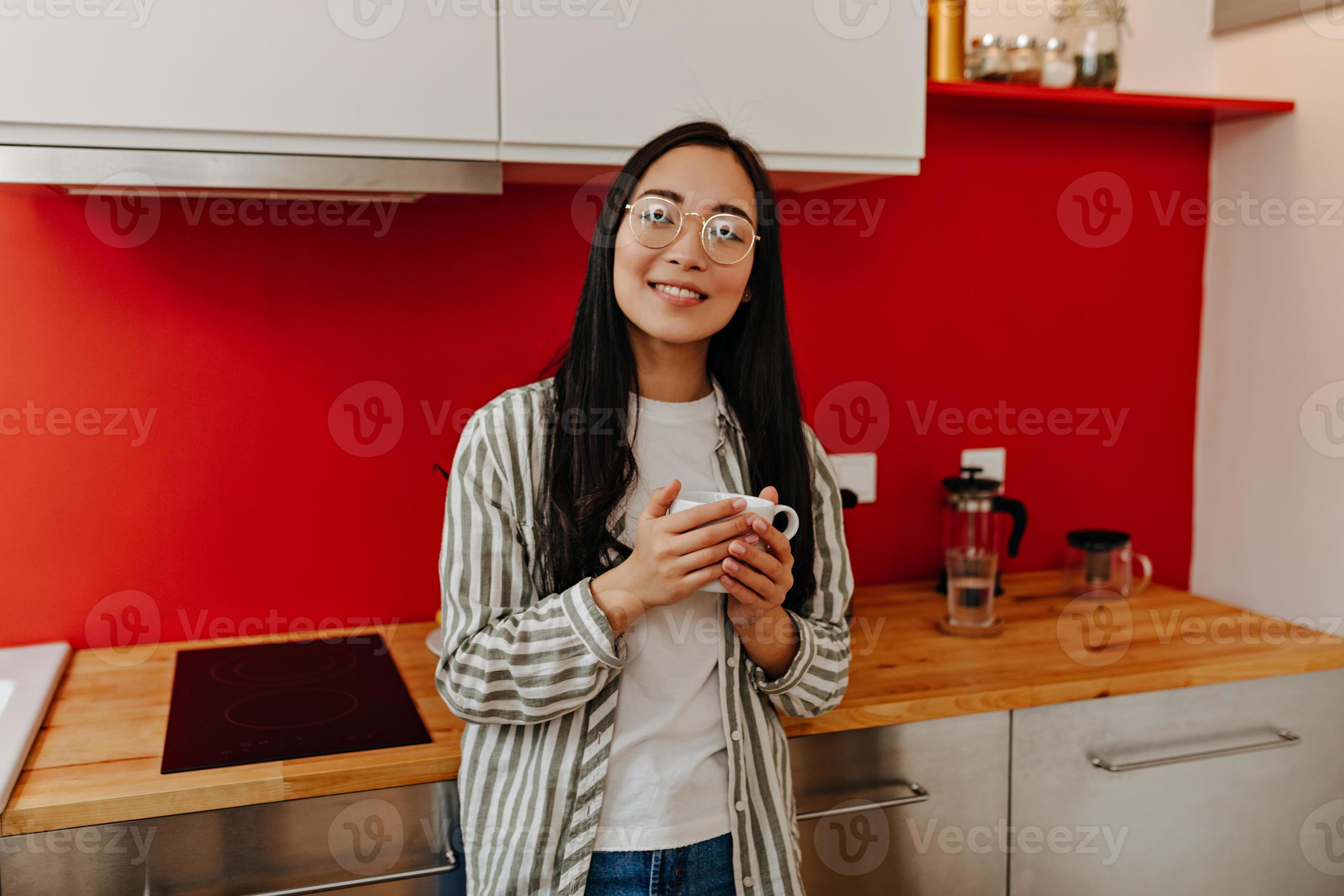 Beautiful Asian Girl In Striped Shirt And Glasses Looks Into Camera And