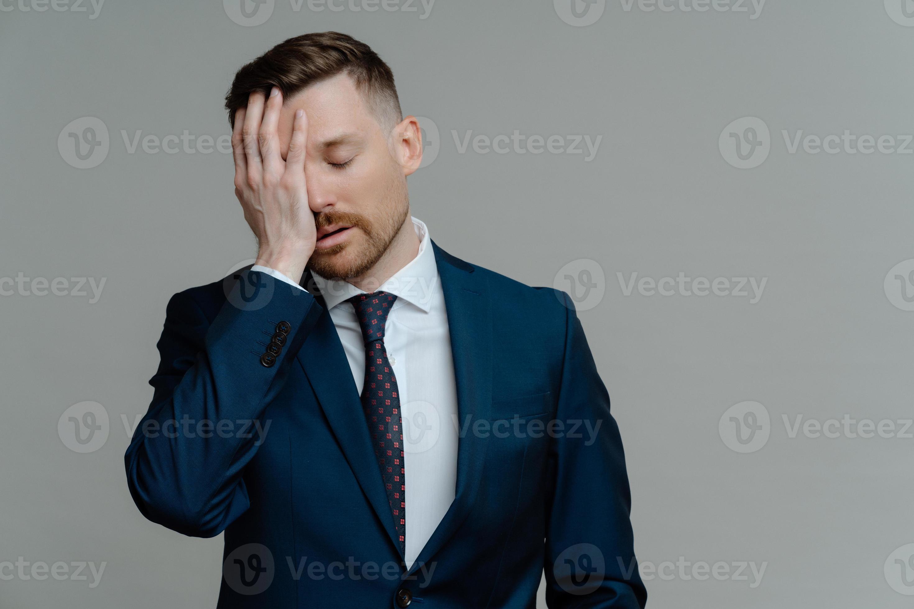 Depressed man in suit feeling sad while receiving bad news 13001824 ...