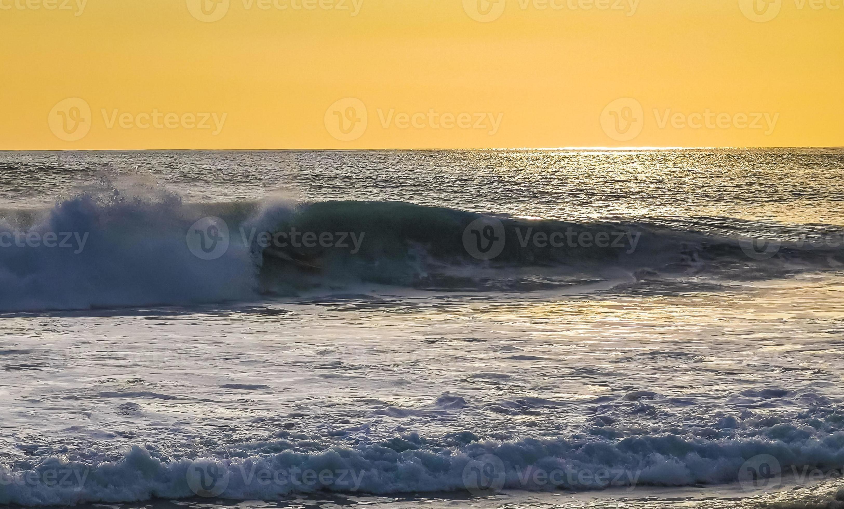 Colorful golden sunset big wave and beach Puerto Escondido Mexico ...
