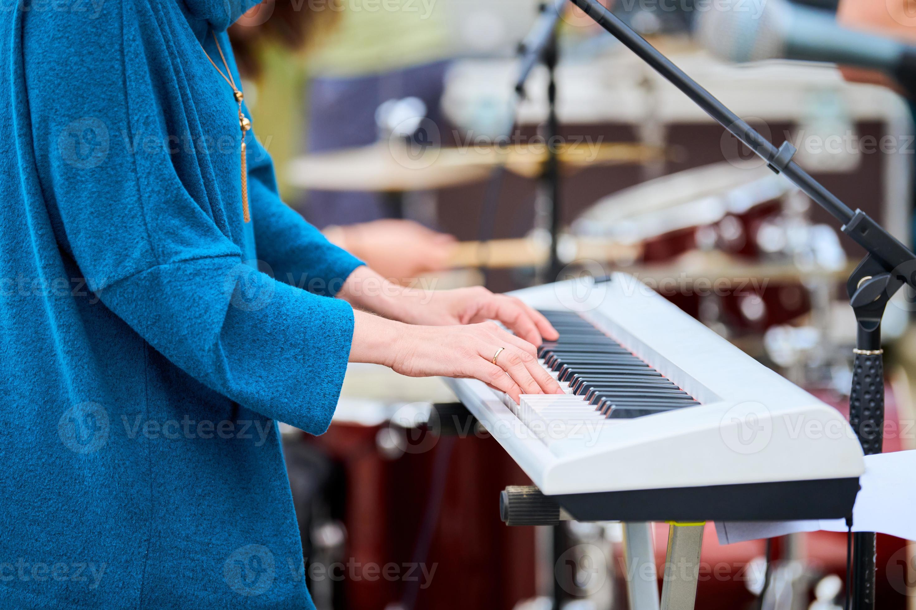 Musician woman playing on synthesizer keyboard piano, hands press ... Musician woman playing on synthesizer keyboard piano, hands press ...