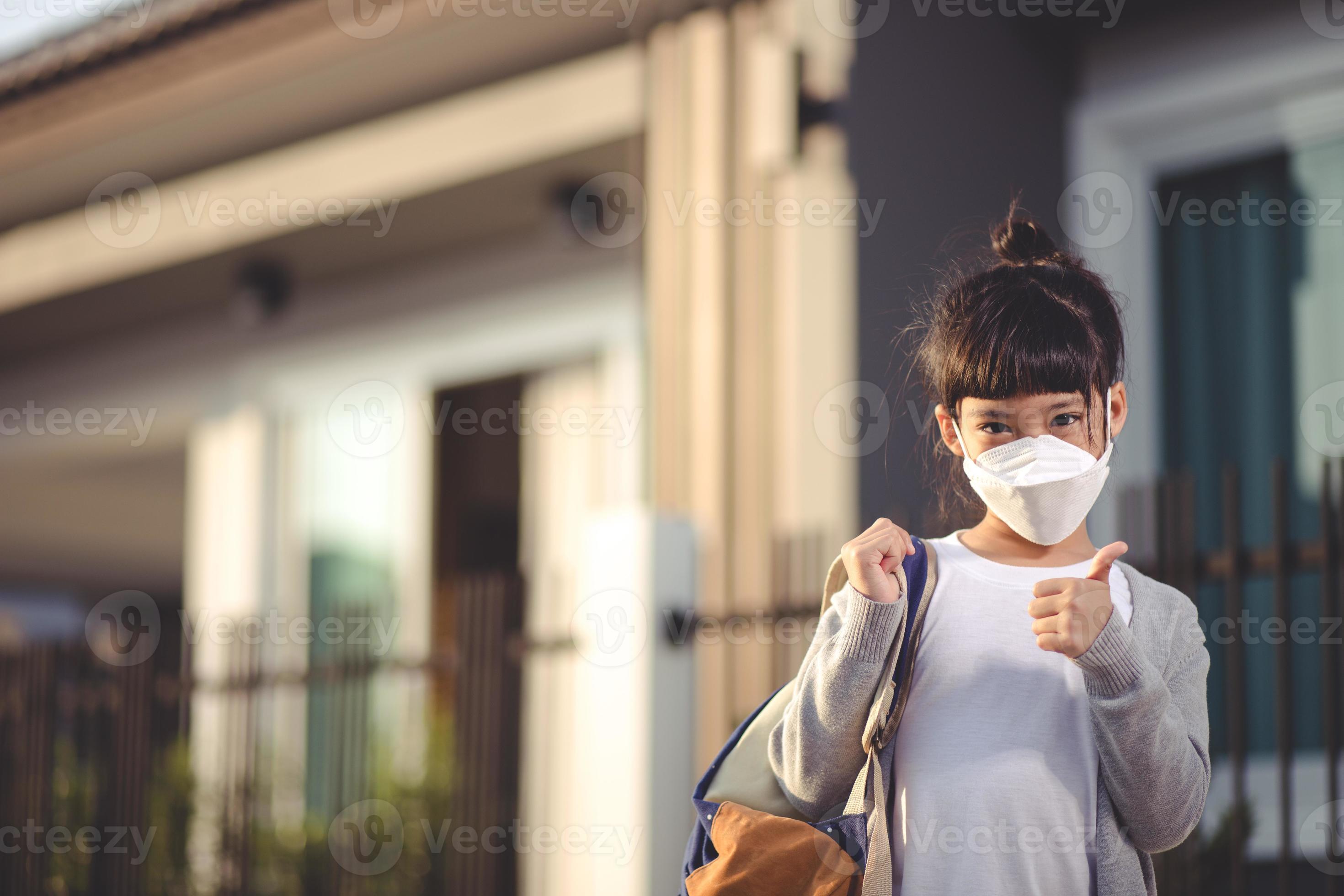 Coronavirus Covid-19 pm2.5.Online education.Little chinese girl wearing face mask show thumbs up ...