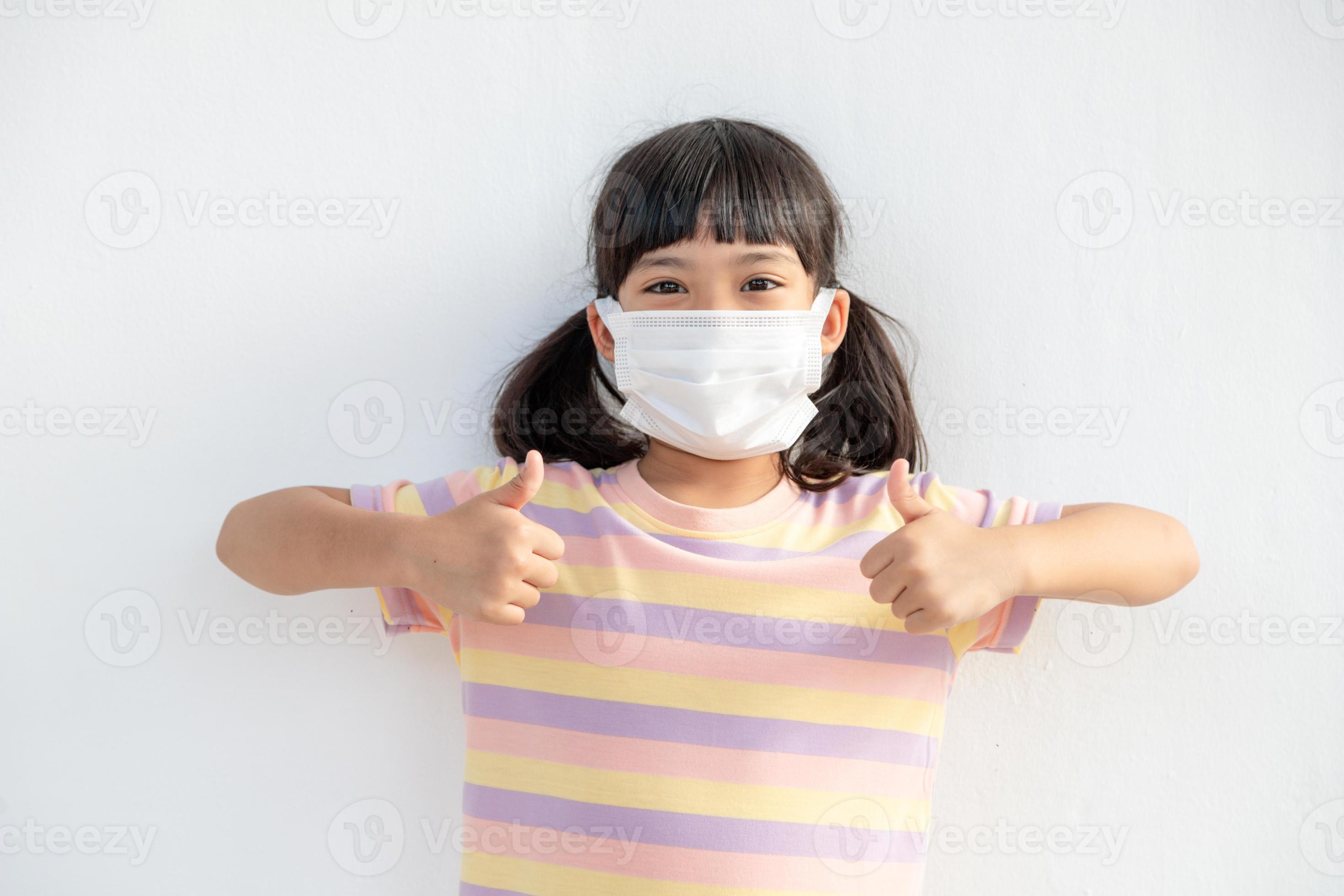 Coronavirus Covid-19 pm2.5.Online education.Little Asain girl wearing face mask show thumbs up ...