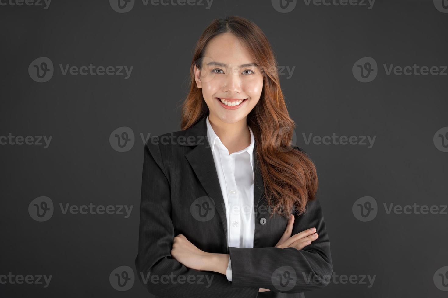 Business woman wearing a black suit Standing with arms crossed ...