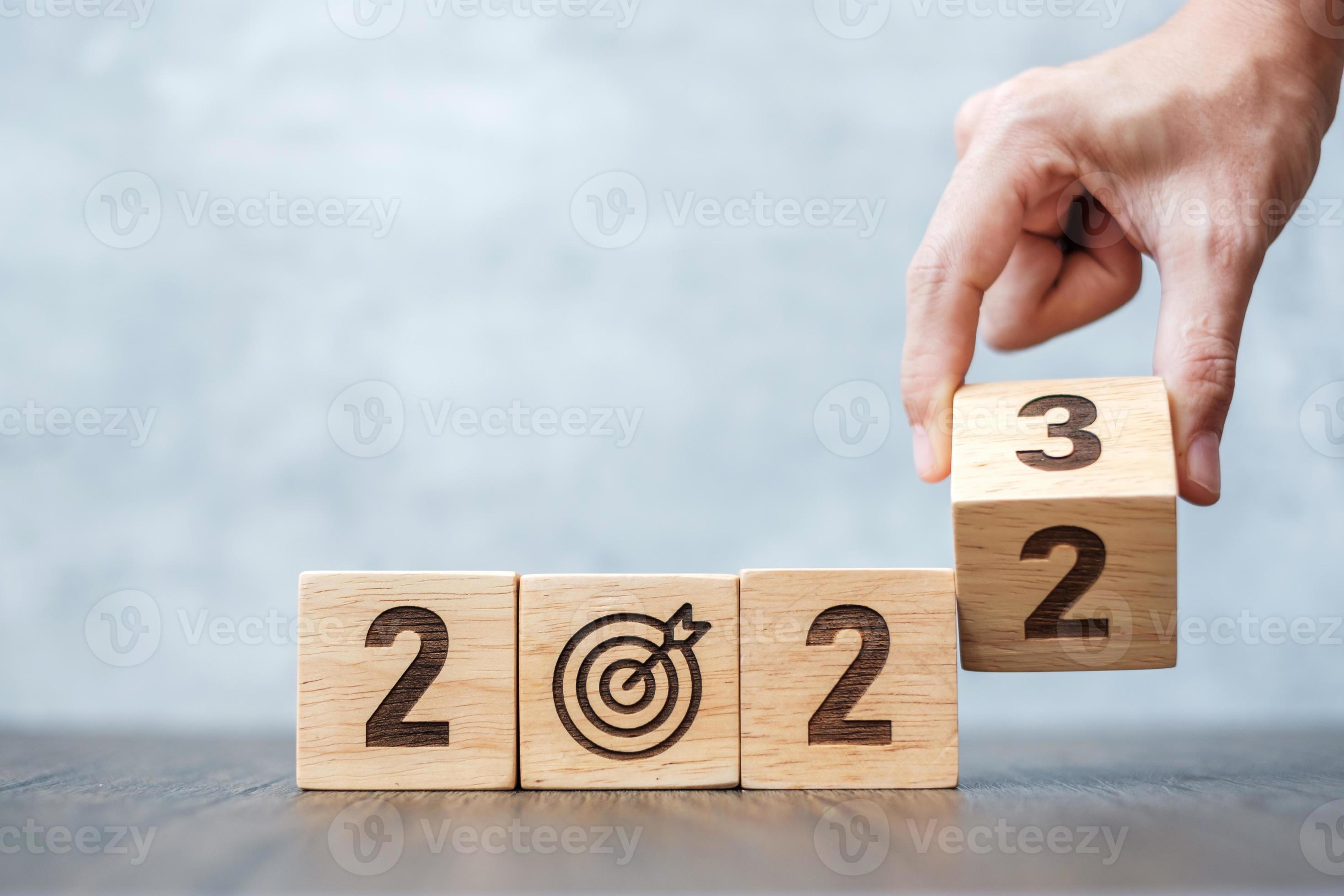 hand flip 2022 to 2023 block with dartboard sign. Business Goal, Target, Resolution, strategy ...