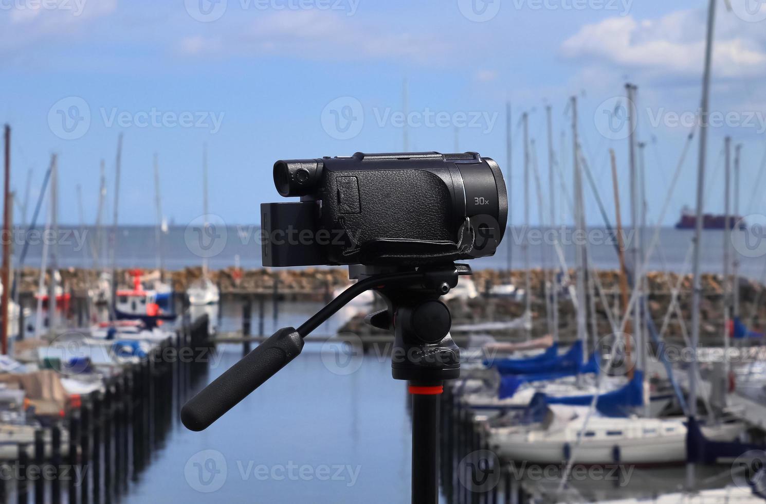 Selective focus view at a camera filming at a yacht port in Kiel in ...