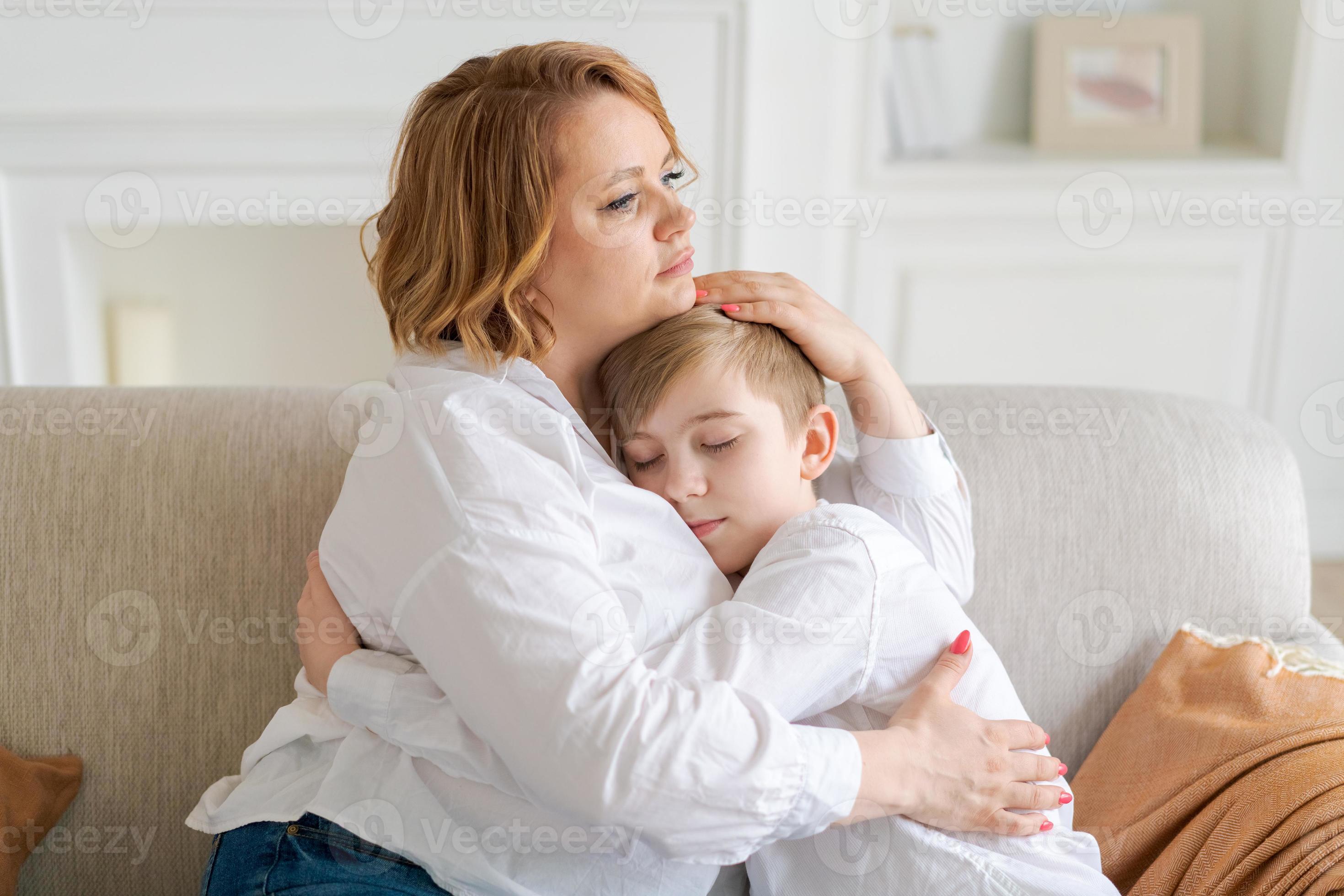 Happy young mom hugs her toddler son, relaxing on sofa at home. Cute toddler 13180261 Stock ...