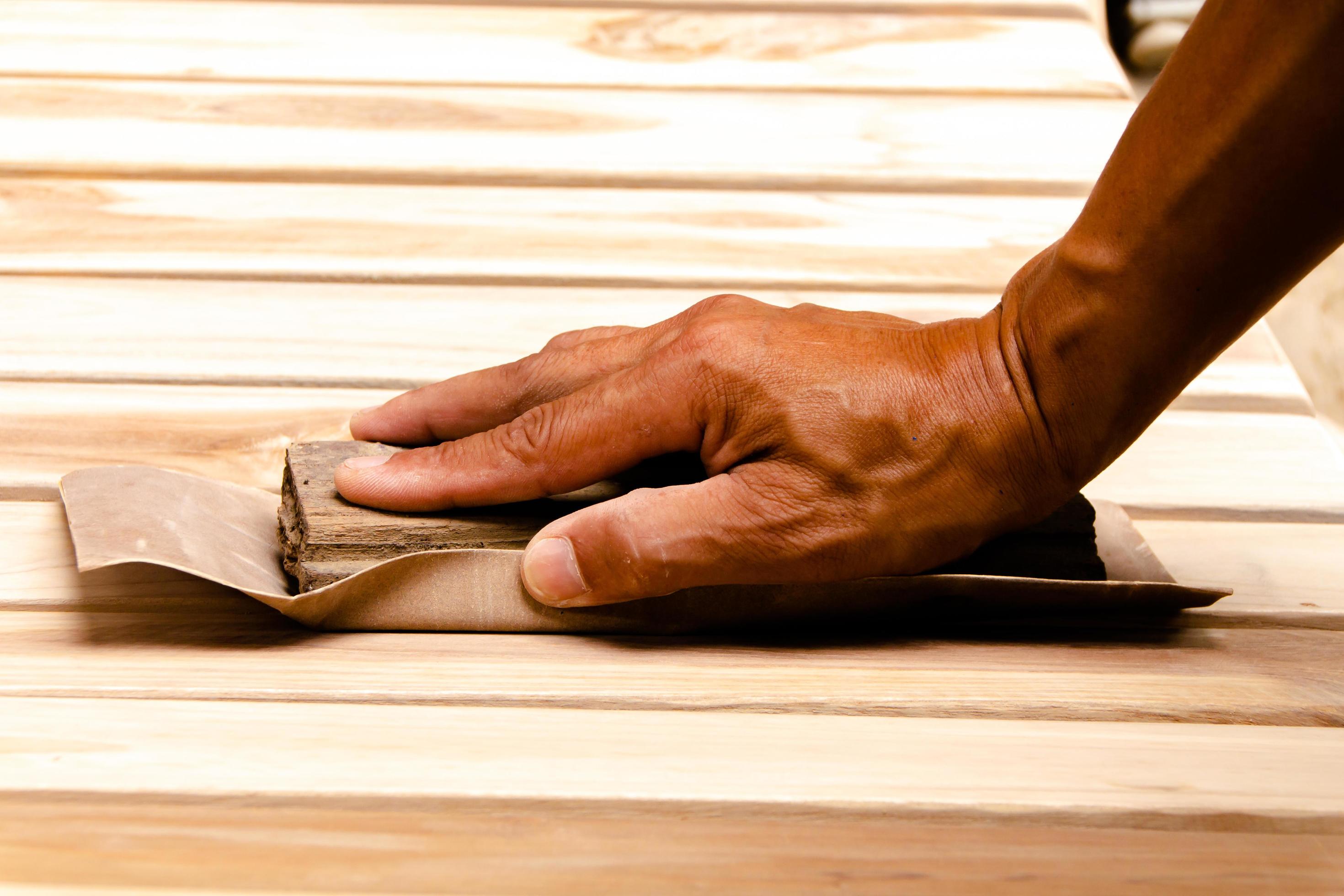 Working to smooth wood and clean with sandpaper 13245549 Stock Photo at Vecteezy