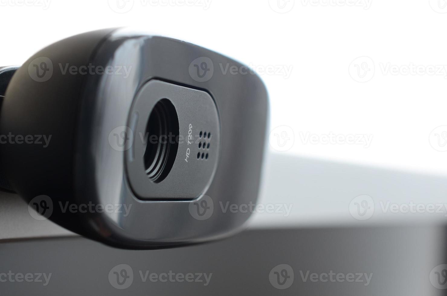 A modern web camera is installed on the body of a flat screen monitor ...