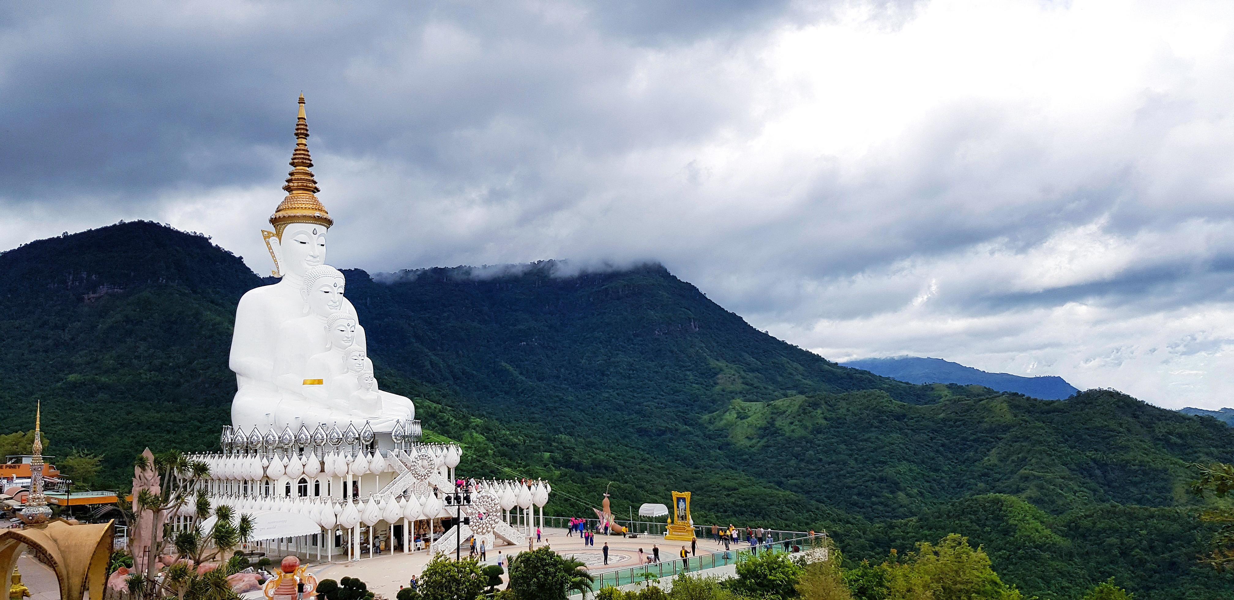 Big white monk statue with green mountain, sky and white cloud background with copy space at ...