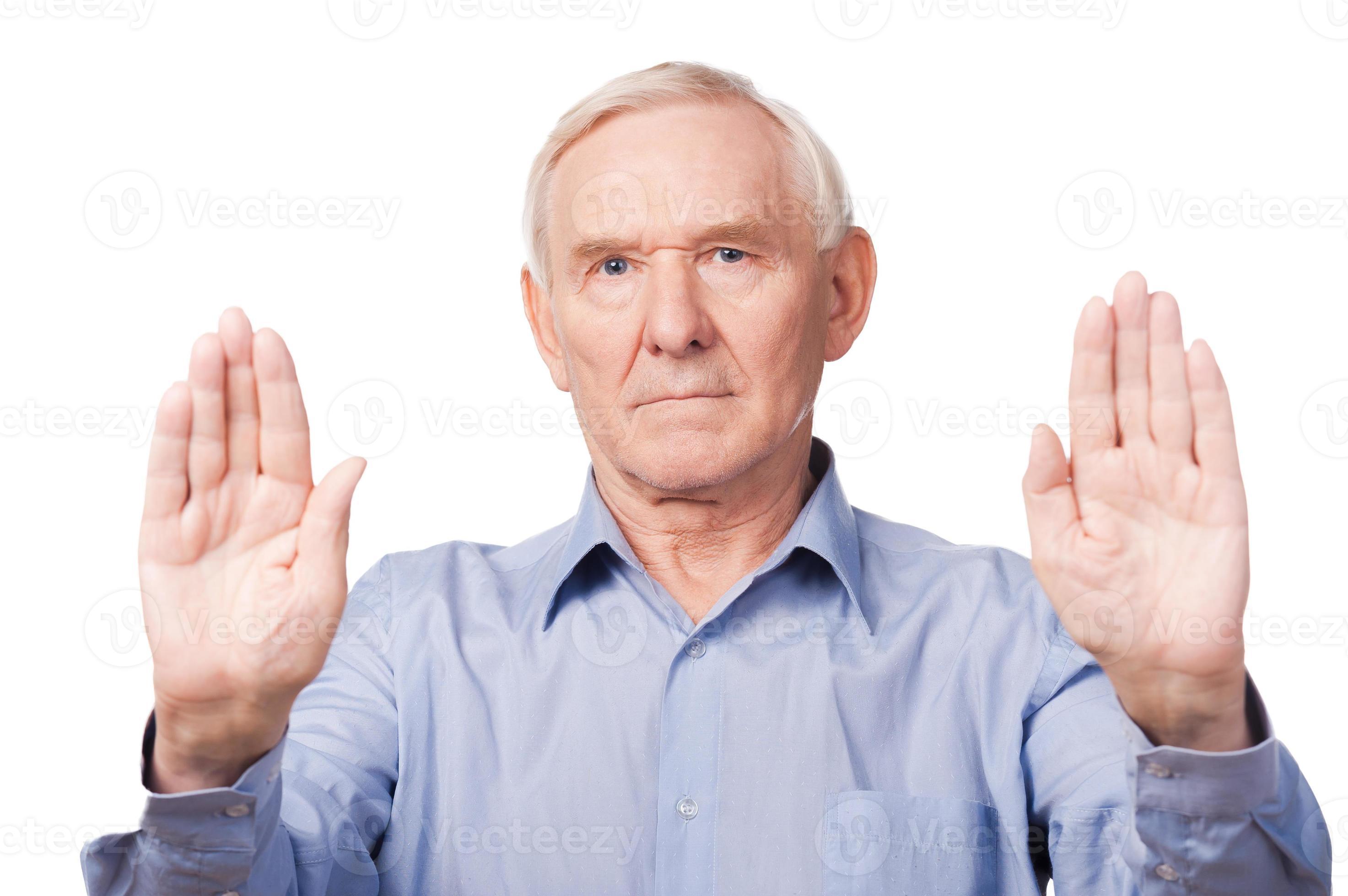 Stop it Serious senior man in shirt showing his palms and looking at ...